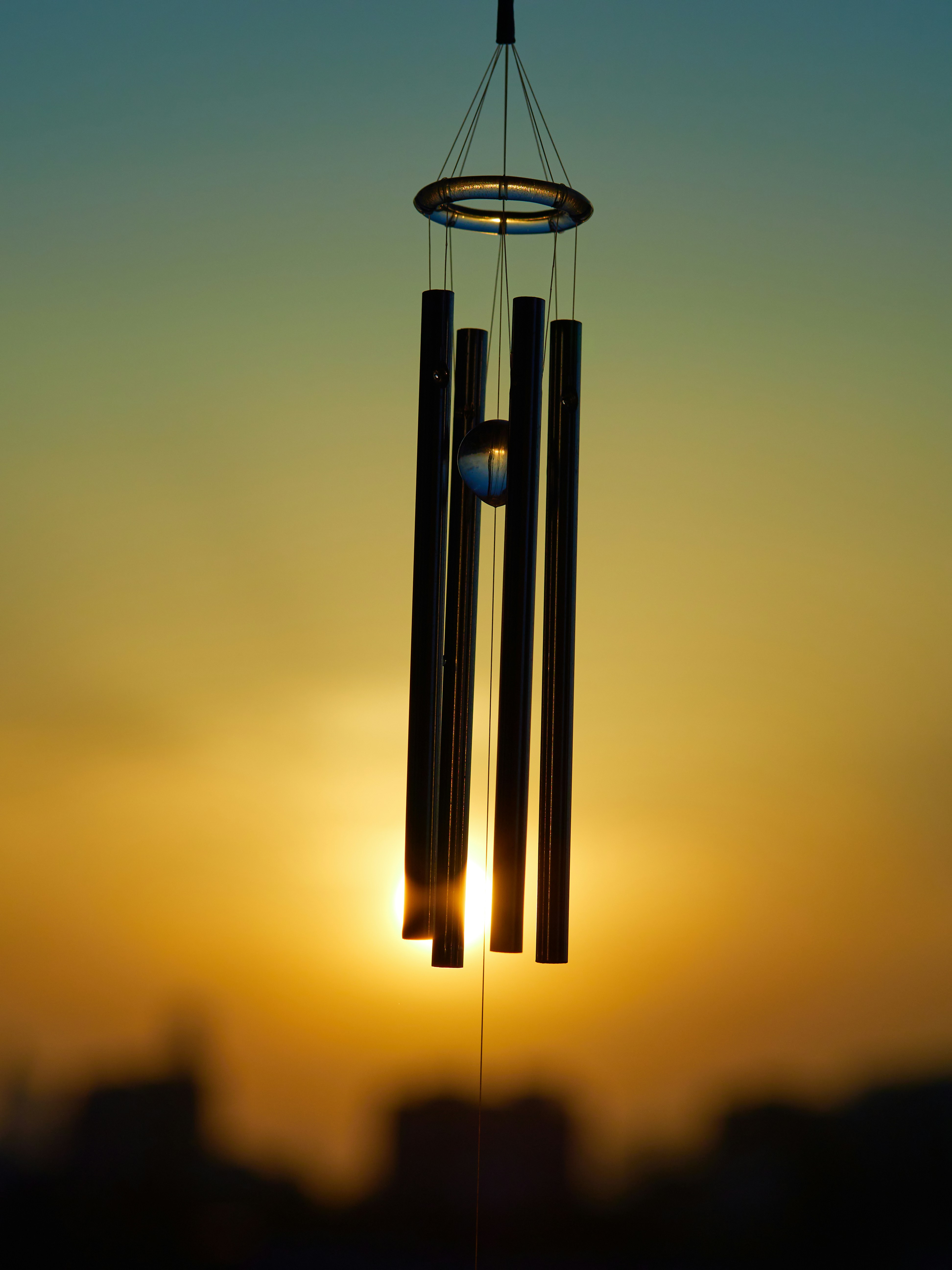 Sunset Wind Chimes: A Silhouette in Low Light