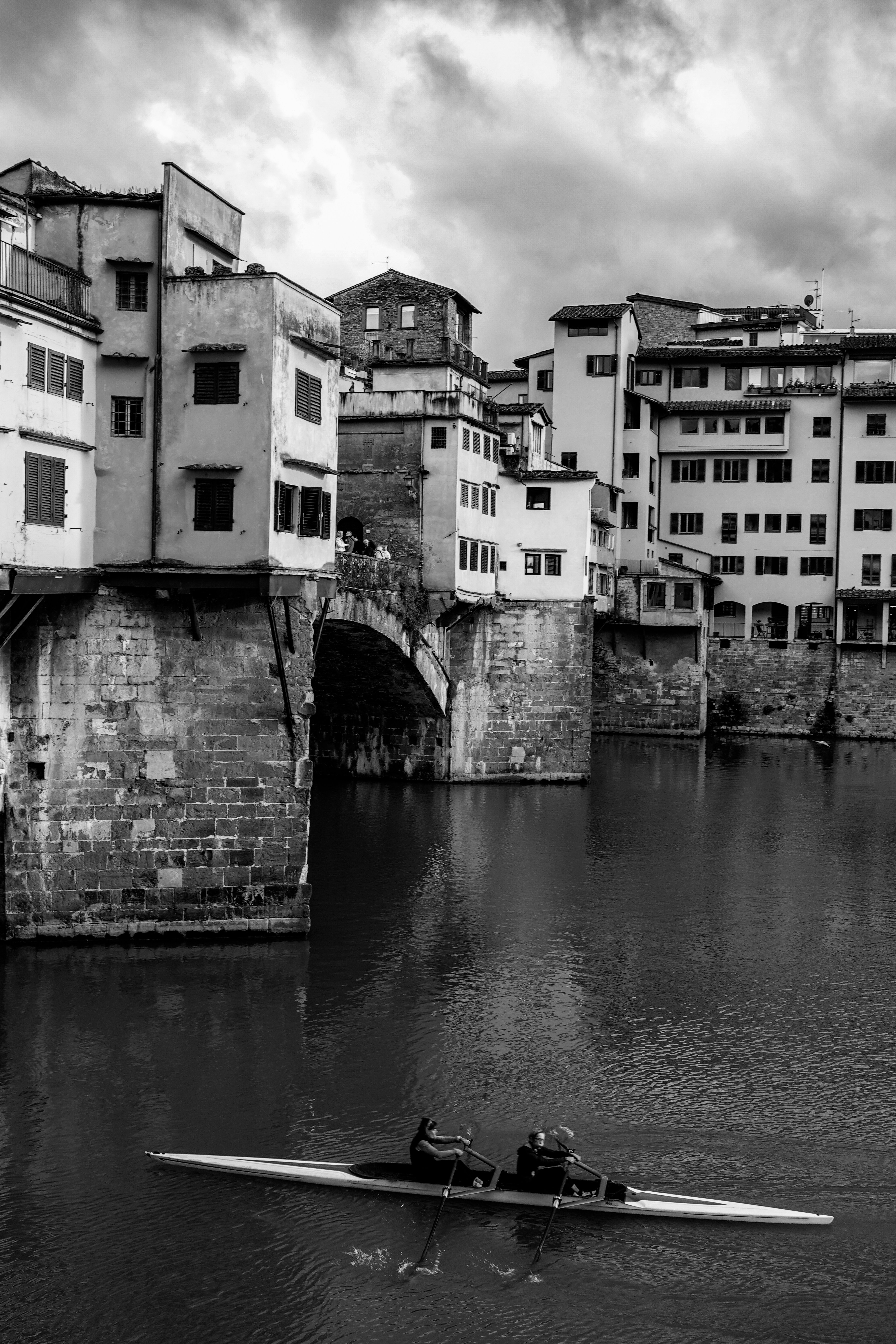 Riverside Arc: A Row of Timeworn Homes Framing a Quiet Coble