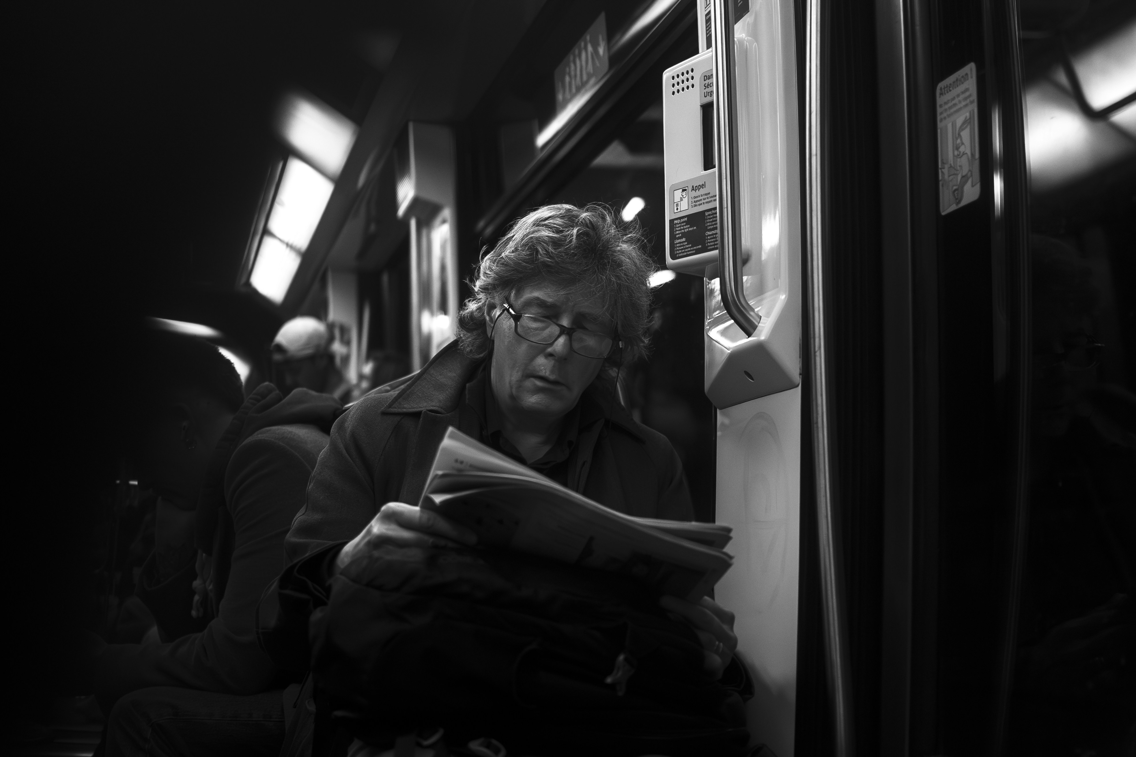 Seat of Knowledge: A Reader in Quiet Sliver of Subway Light