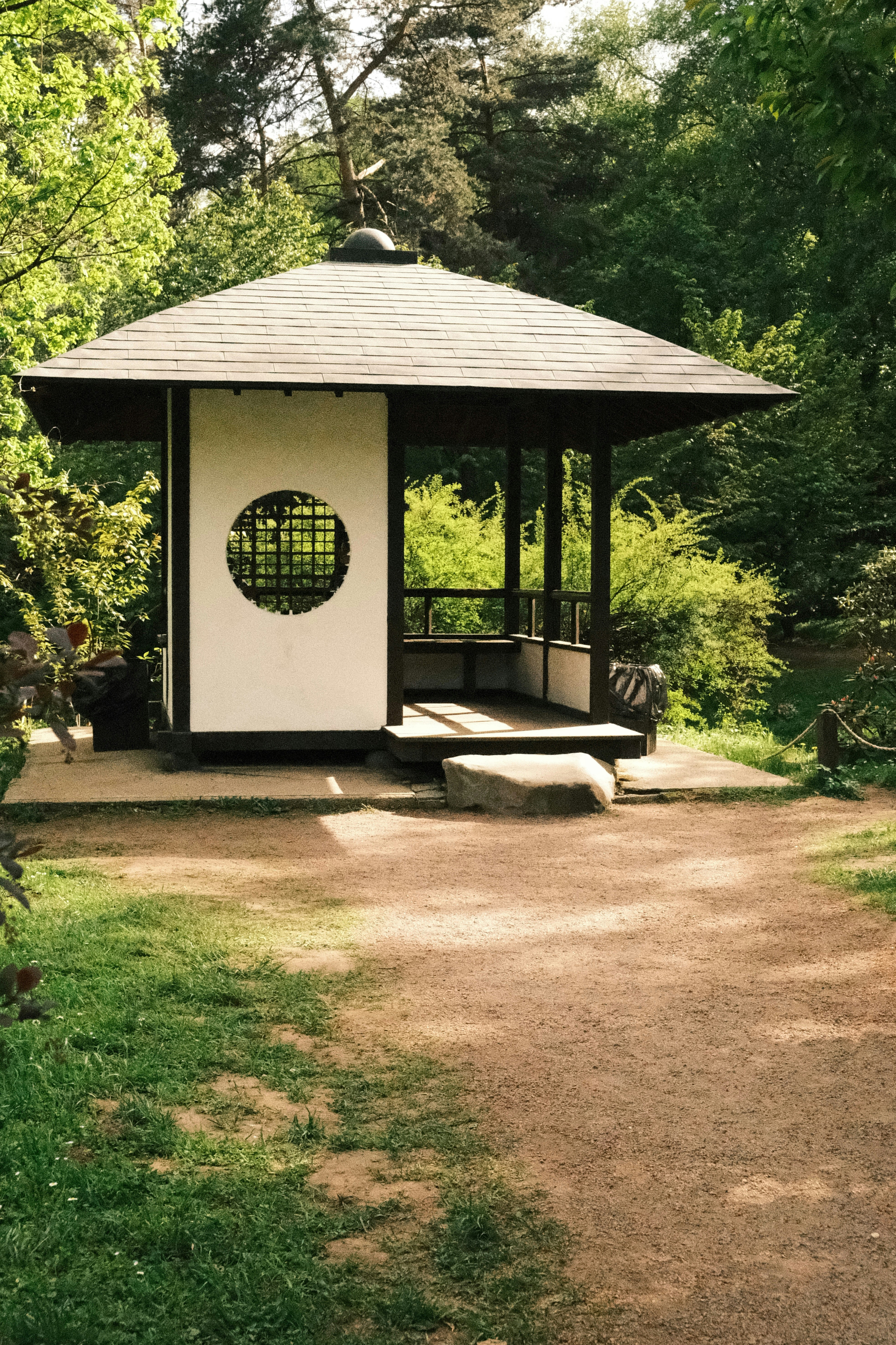Quiet Pavilion by the Path in Sunlit Garden