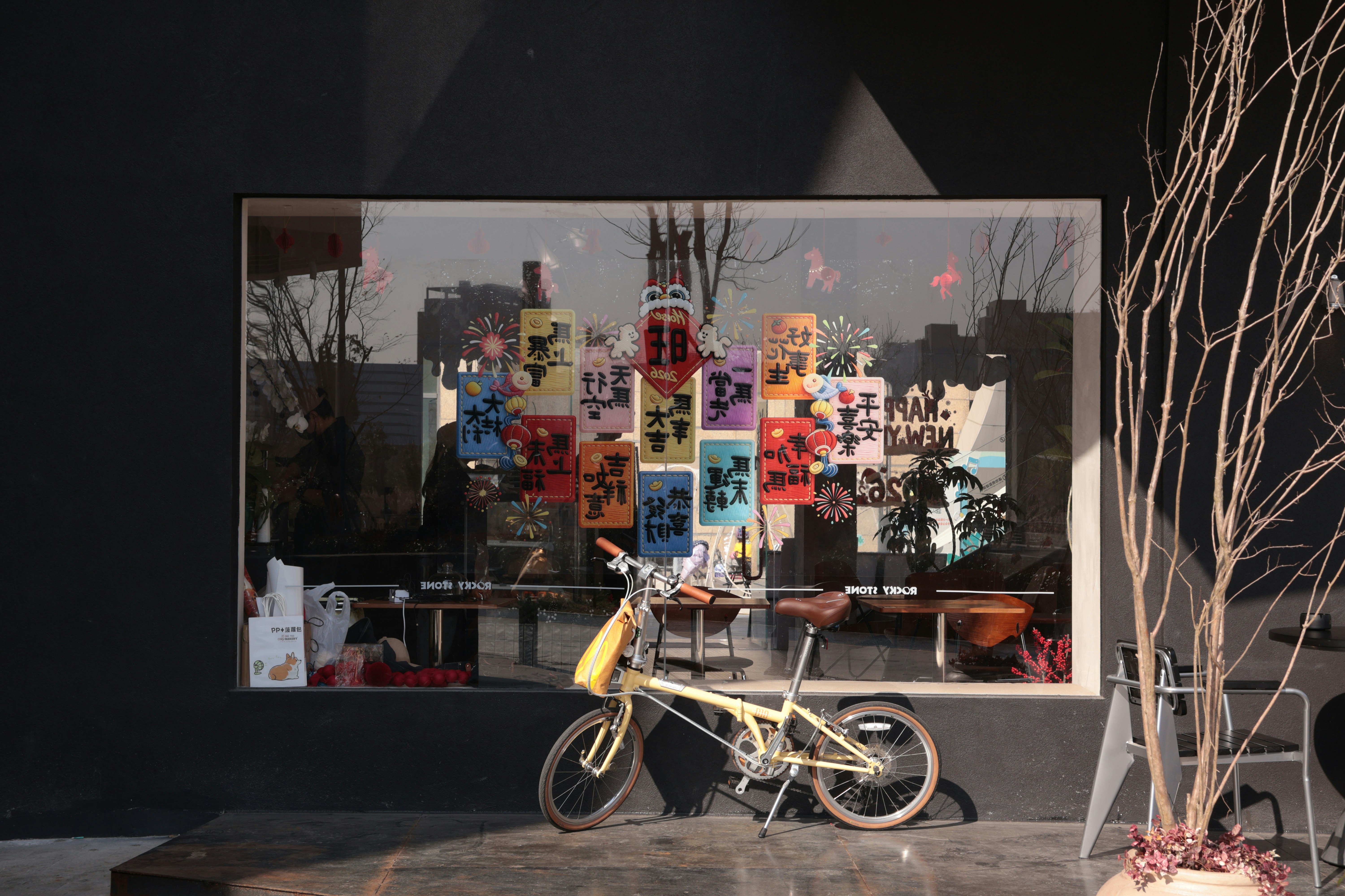 Yellow Bicycle in Front of Colorful Window Art