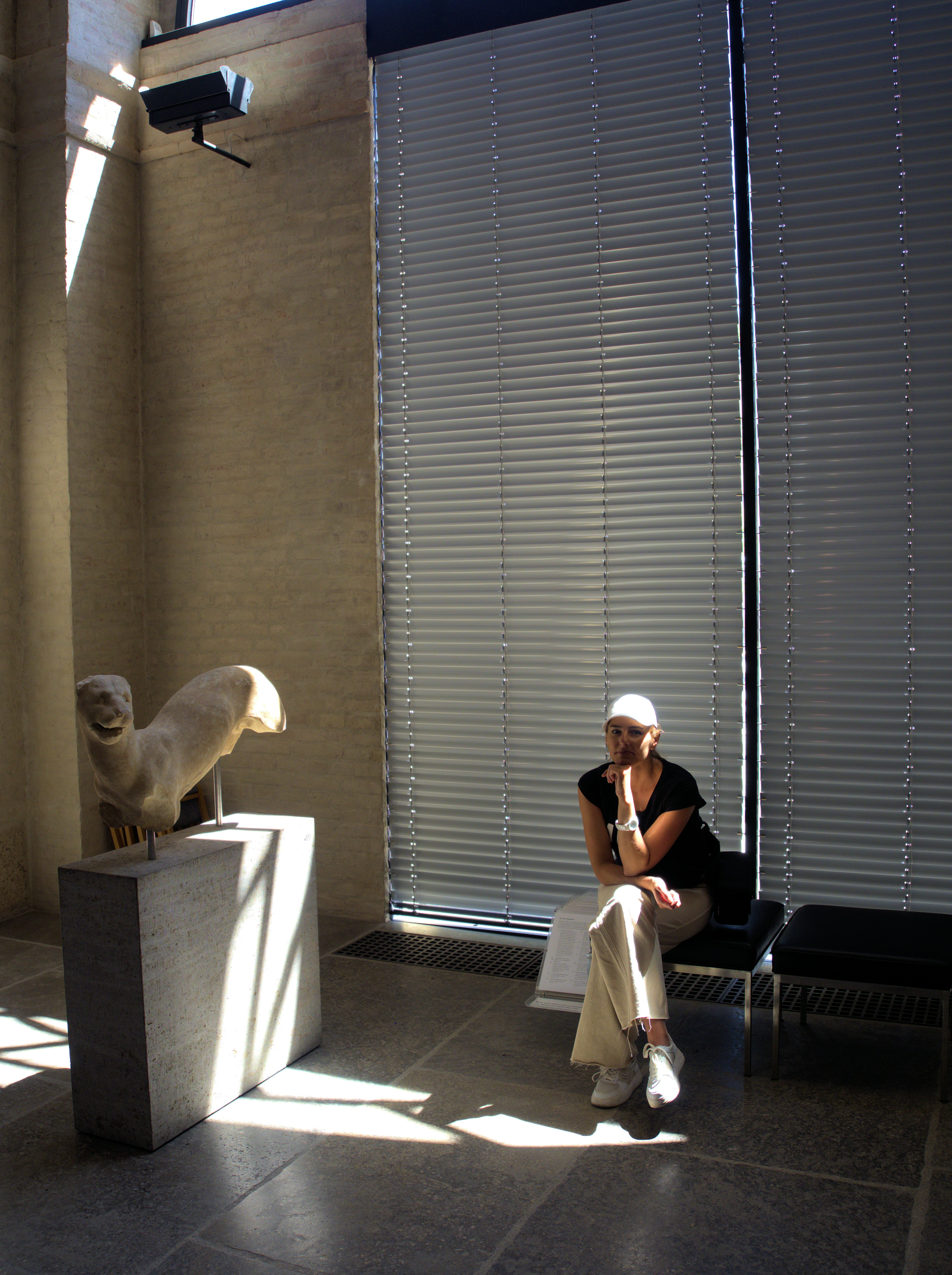  Waiting in the Sun: A Quiet Moment with a Sculpted Figure