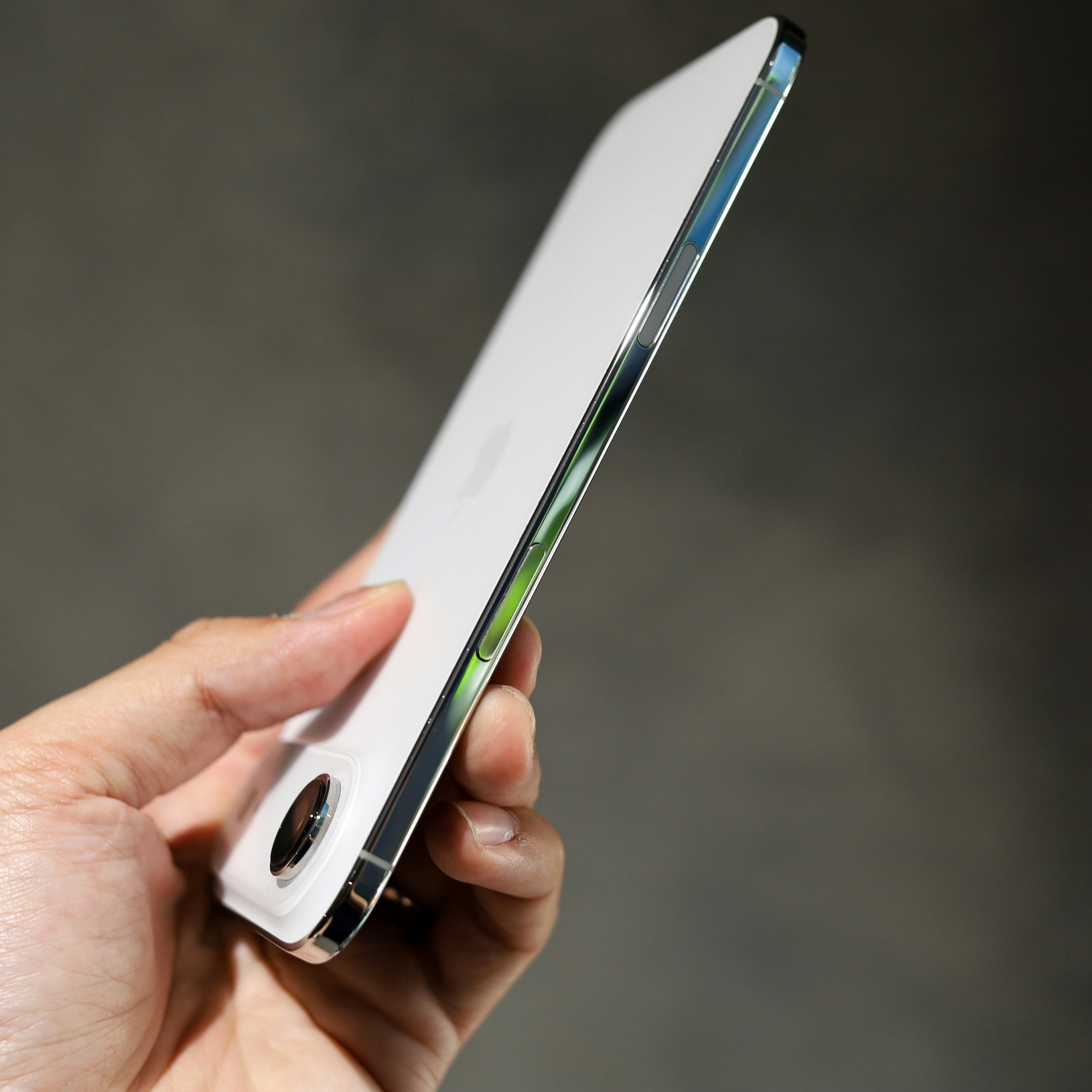 Slim profile, bold presence: the white smartphone held at a precise angle
