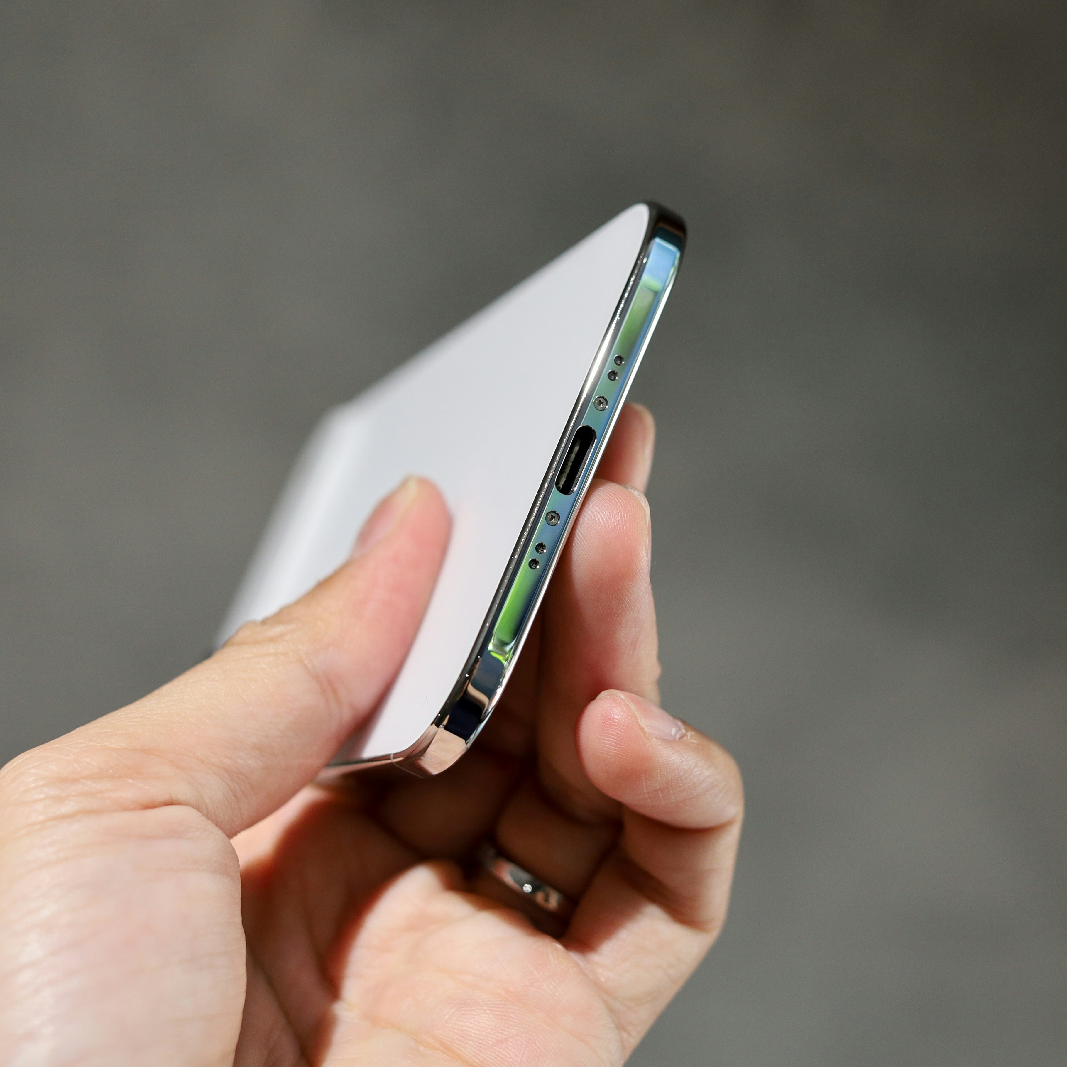 Slim Silver Edge: A Quiet Moment with a Pocket-Sized Device