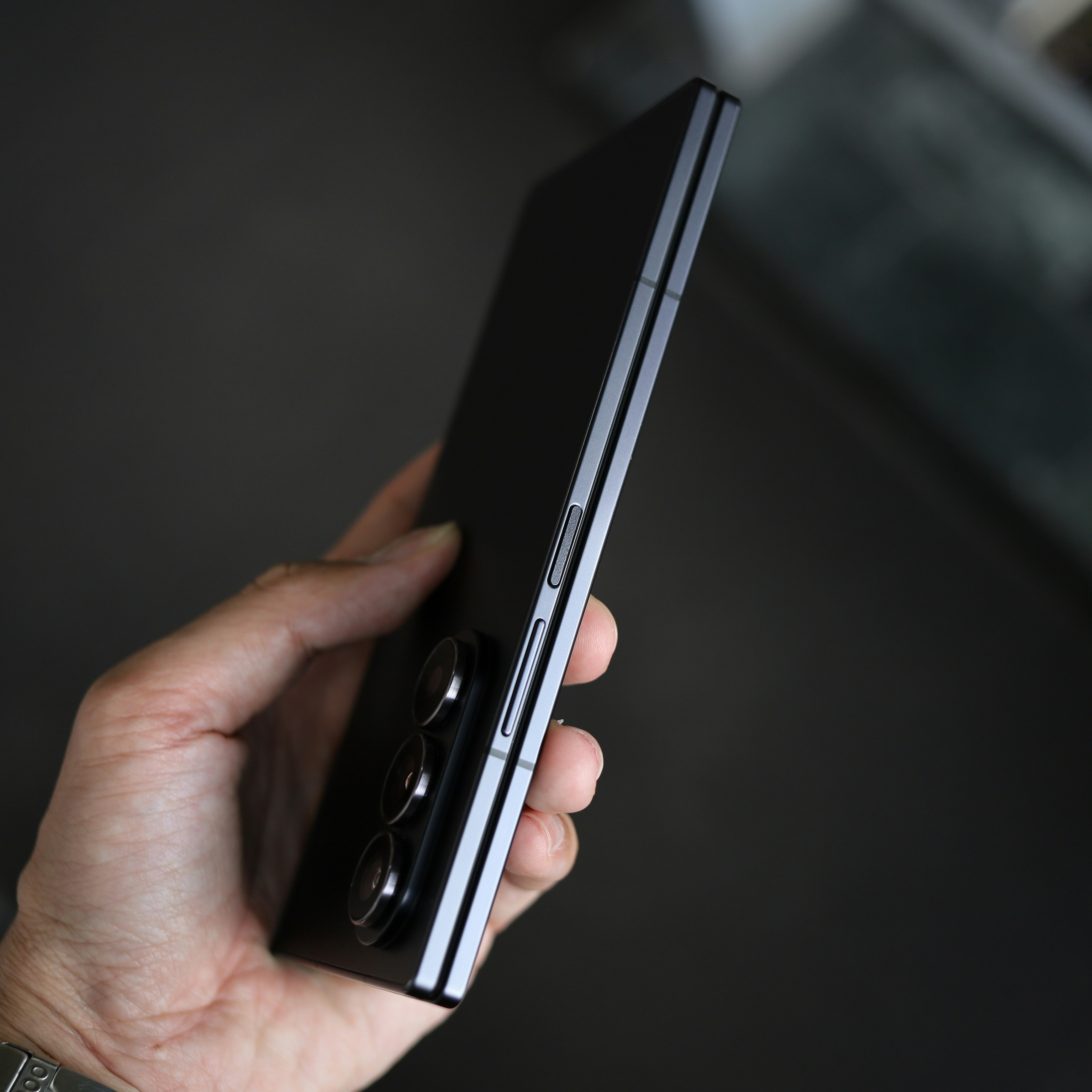 Side View of a Modern Smartphone with Dual Camera Array Gripped in a Hand