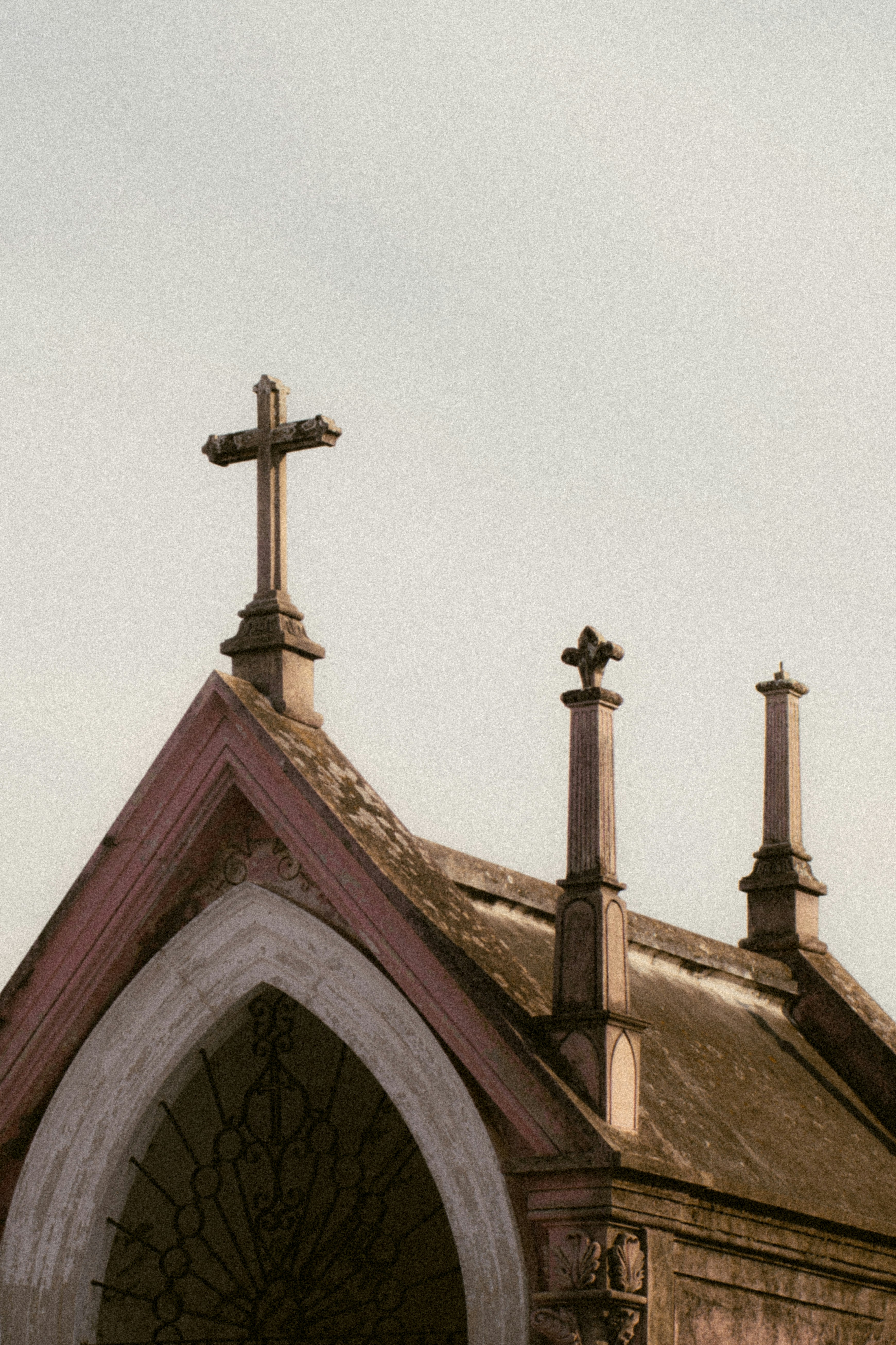 Gothic Rooflines: Weathered Spires Against a Pale Sky