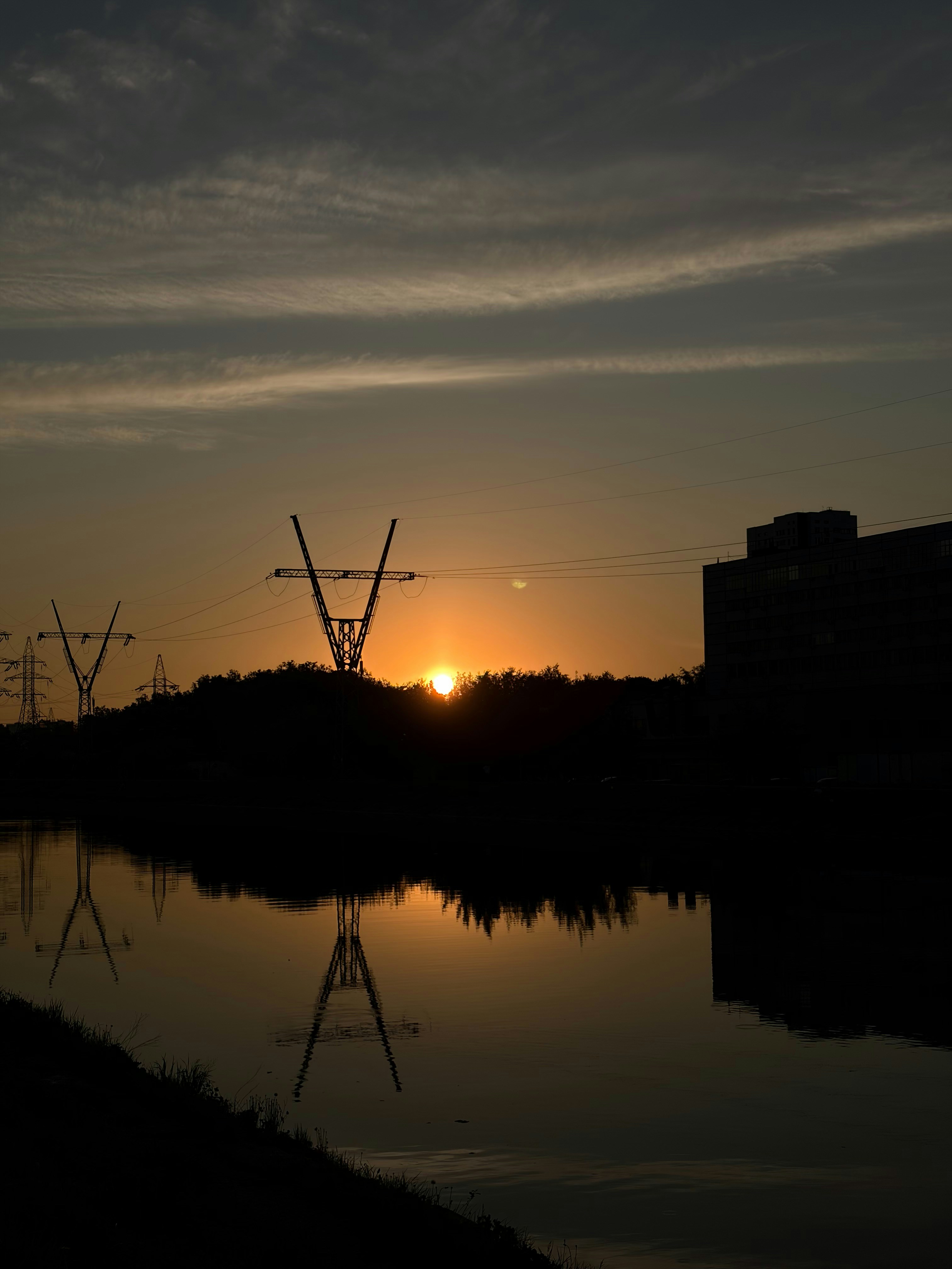 Sunset on the River: Silent Reflections and Power Lines