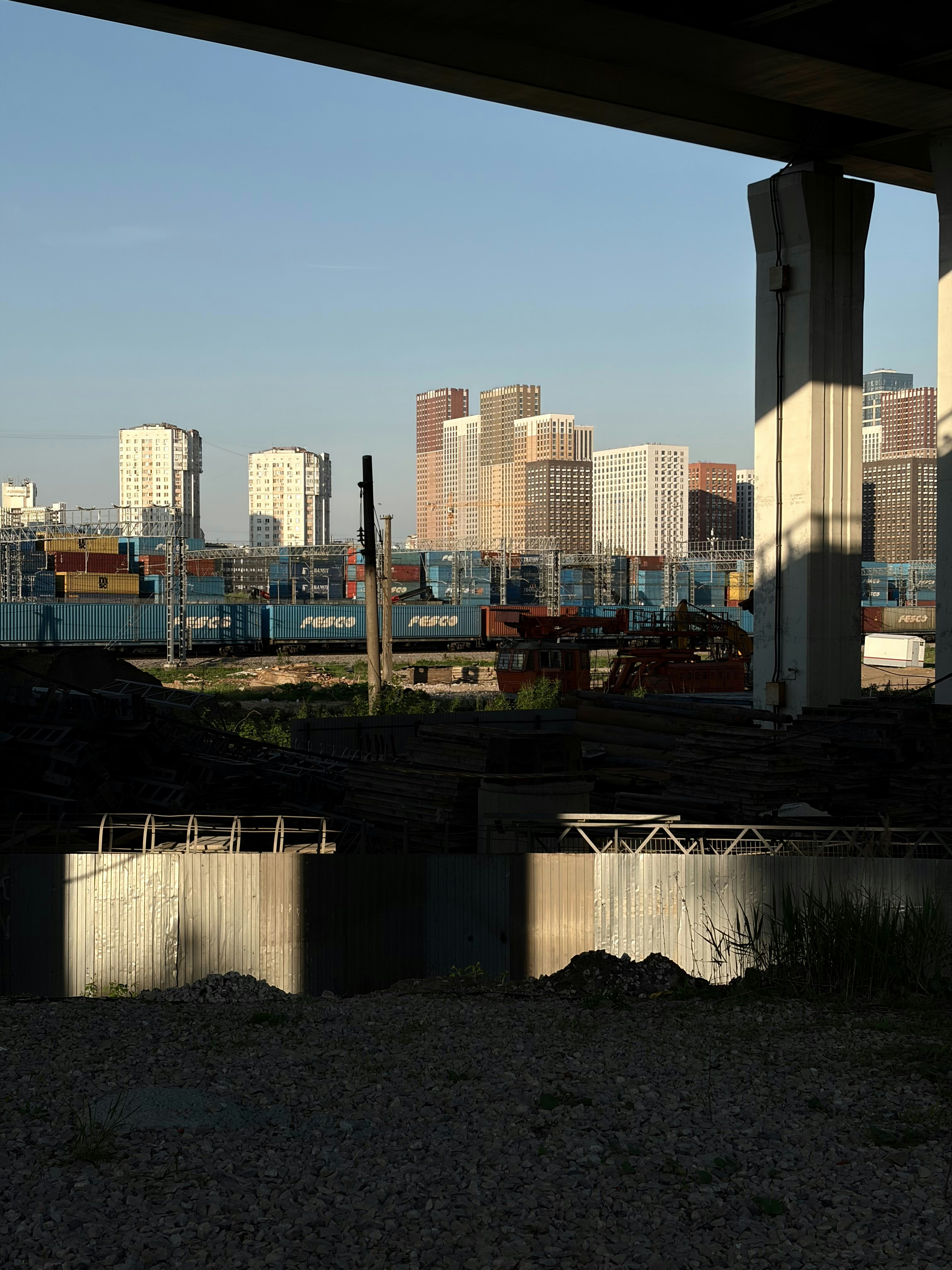 Cityscape Rise: Sunlit Towers Behind a Shadowed Construction Scene