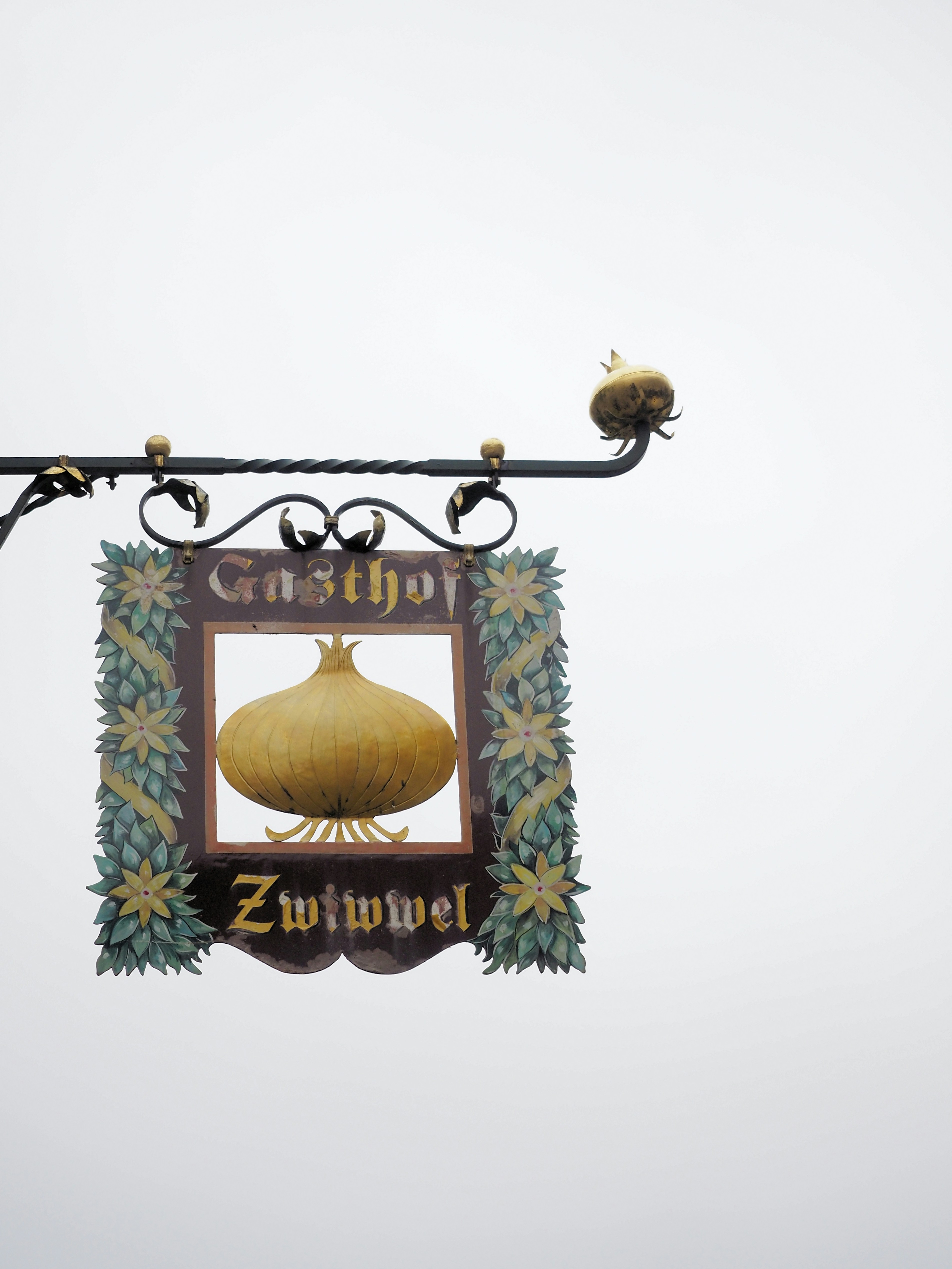 Ornate Signboard Framing a Golden Onion Emblem