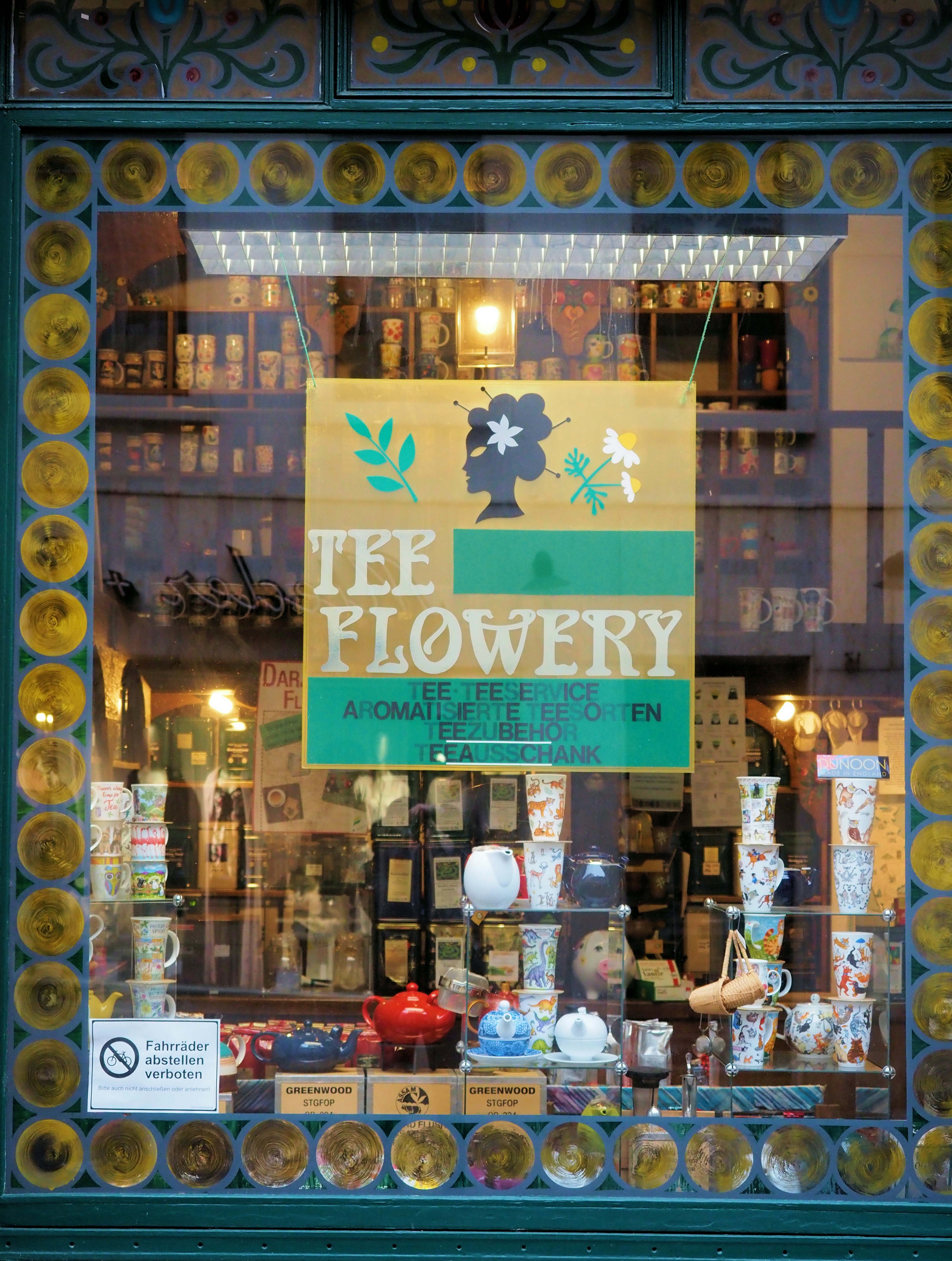 Window of Color: A Tea Shop Sign Framed by a Mosaic Crest