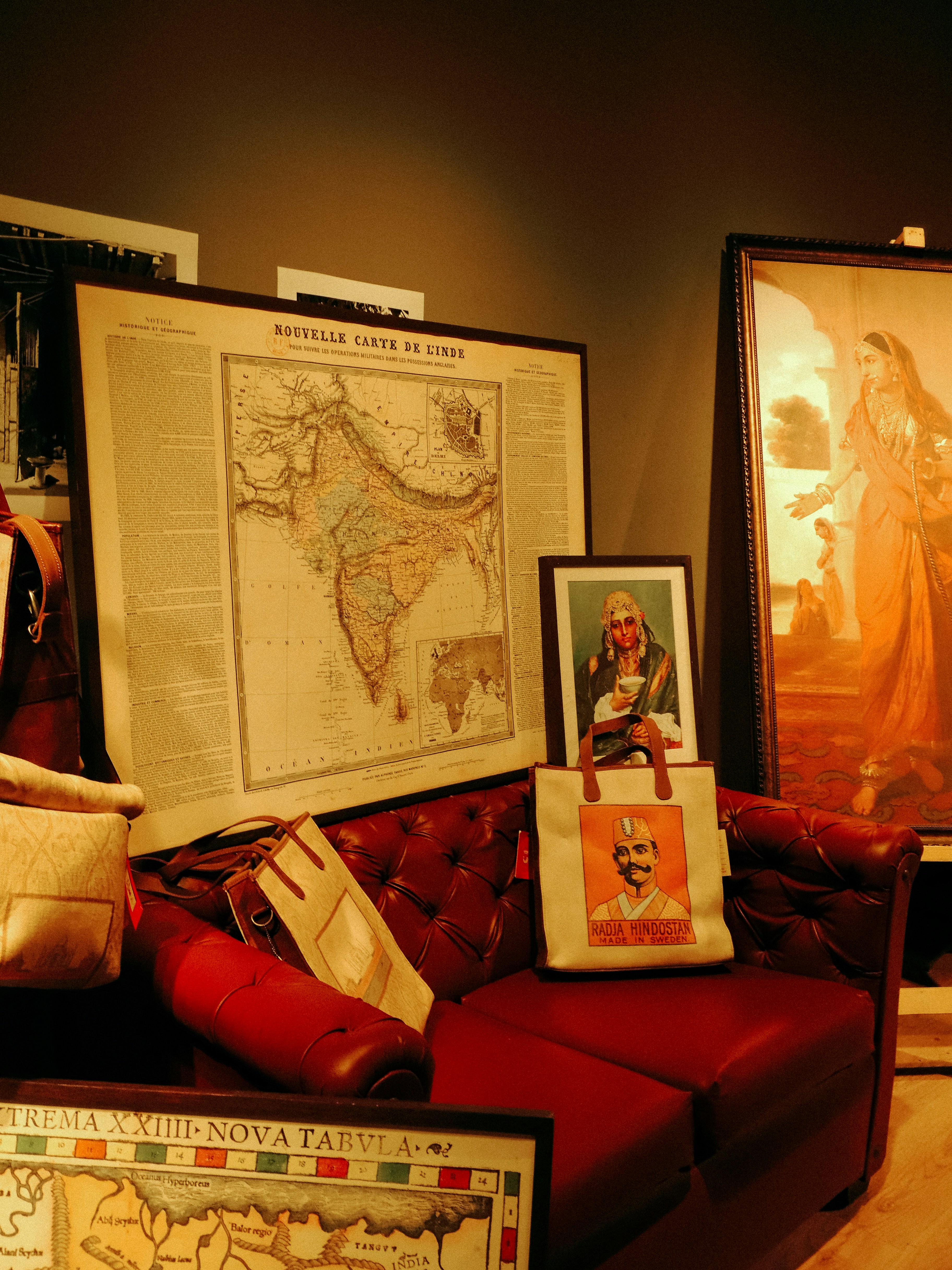 Curated Corners: Vintage Maps, Portraits, and Red Leather Seating