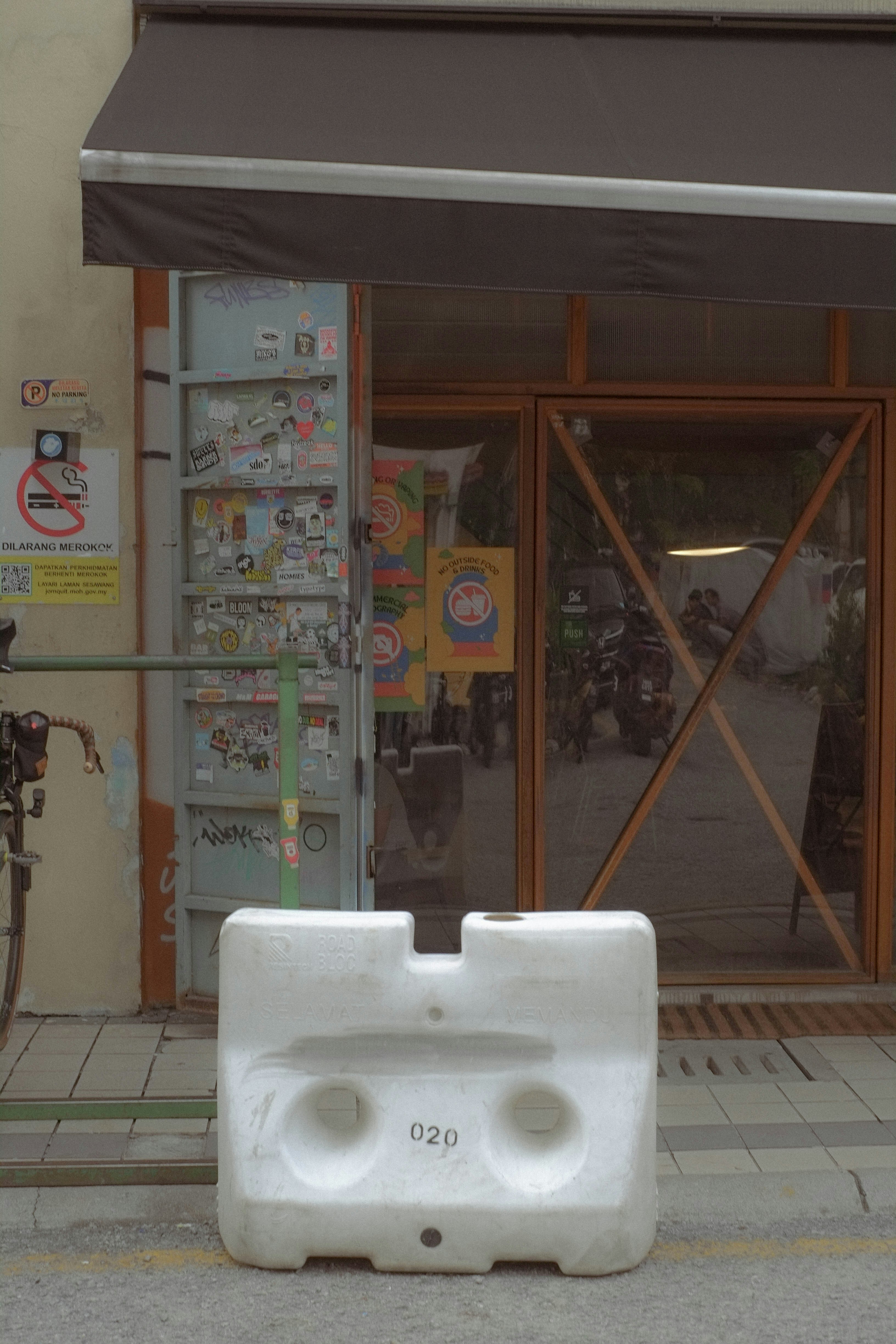 Concrete Barrier Guards a Quiet Shopfront