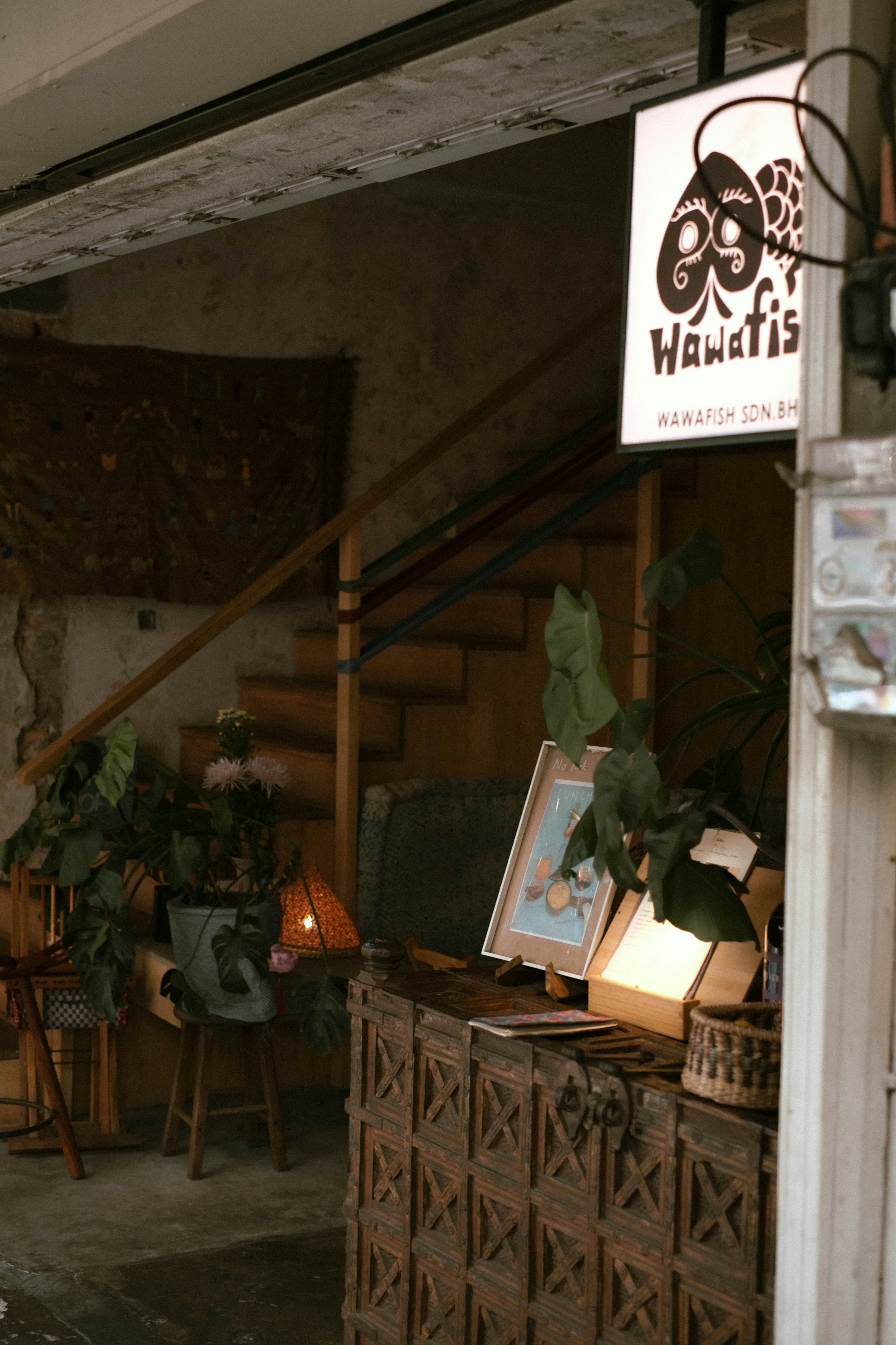 Warm Interior Glow: A Quiet Shop with Wooden Details and a Welcoming Sign