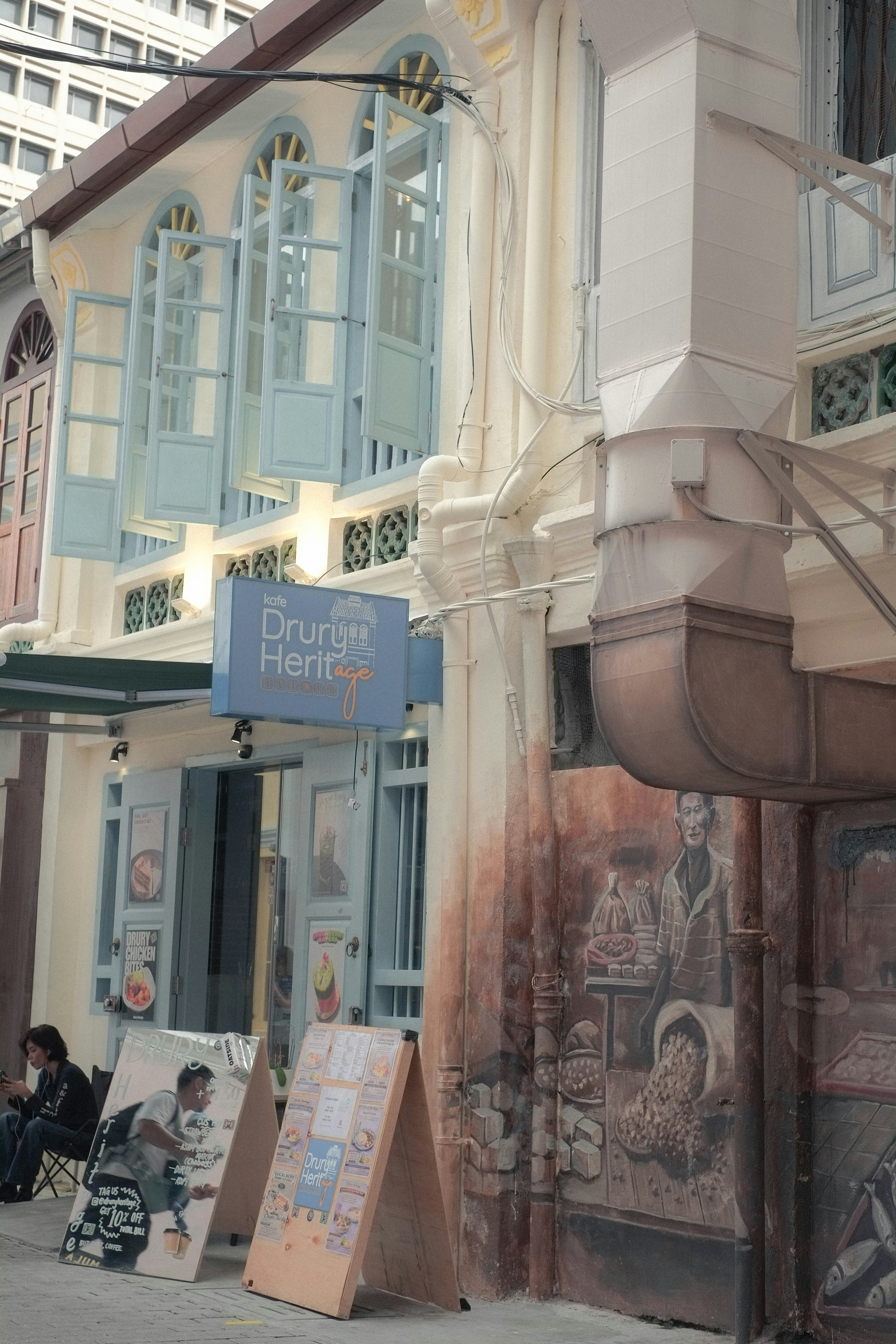Heritage Streetfront: Open Windows and Painted Wall Amid Urban Charm