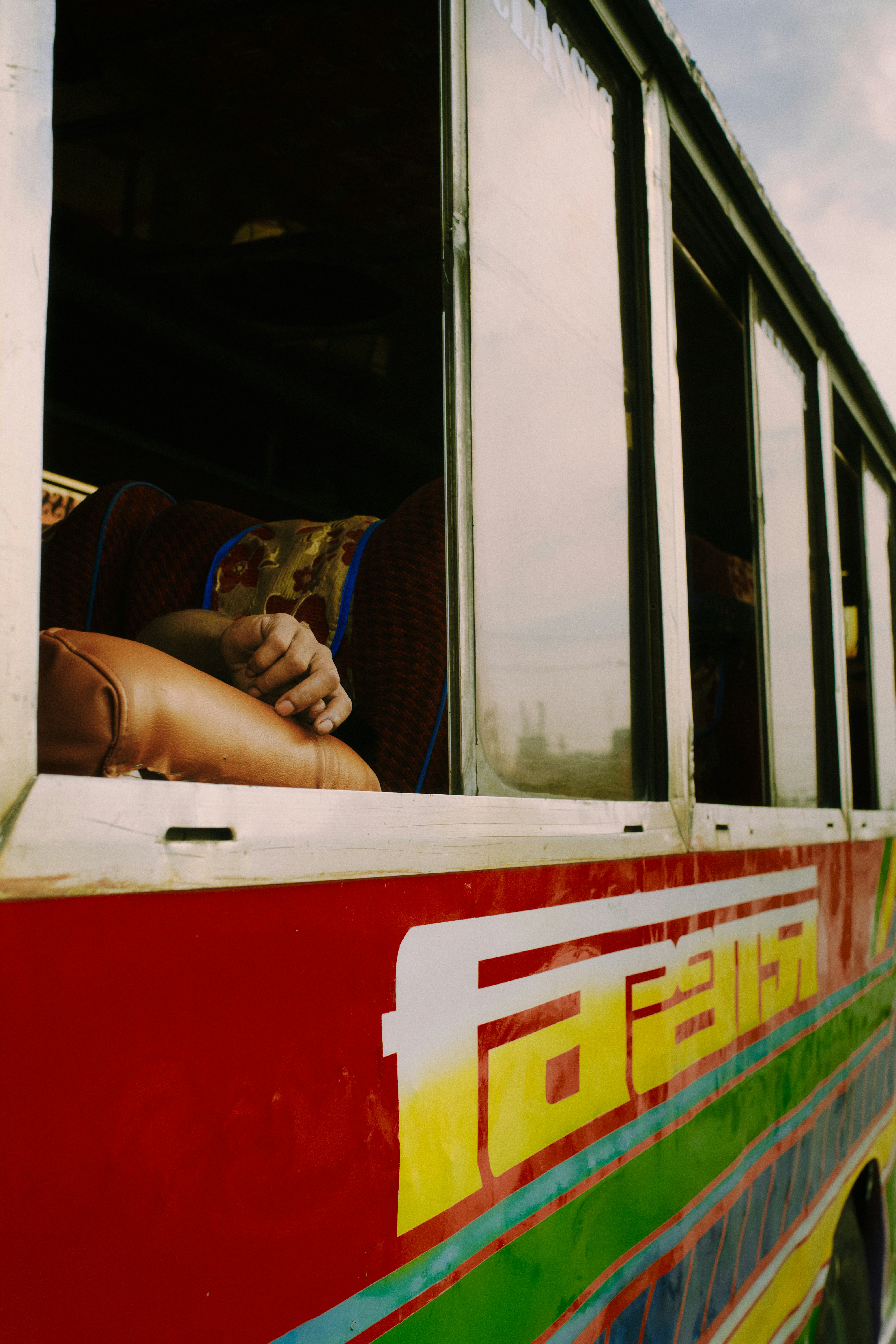Sleeper on a Colorful Bus Window