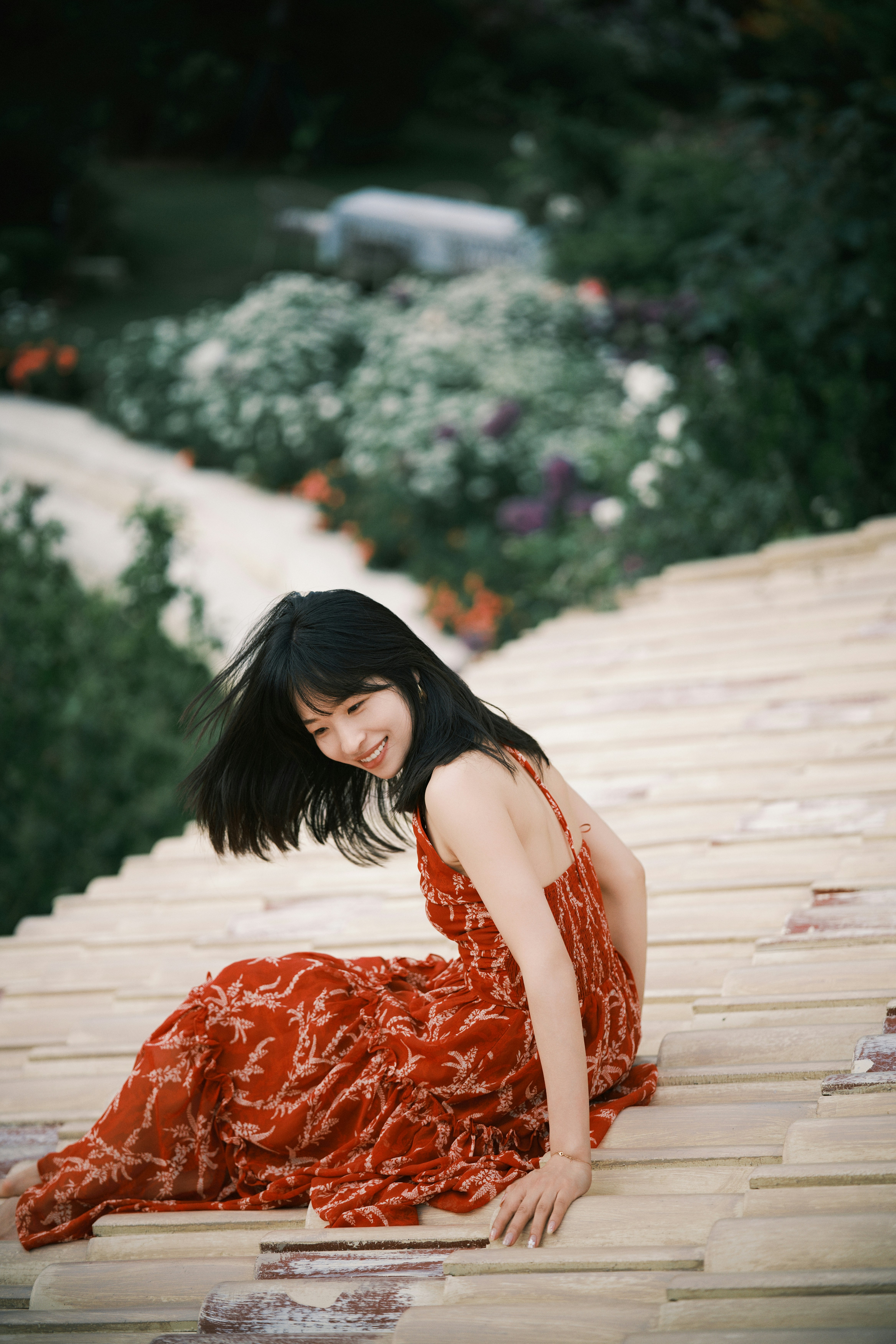 Woman in Coral Dress on Weathered Steps