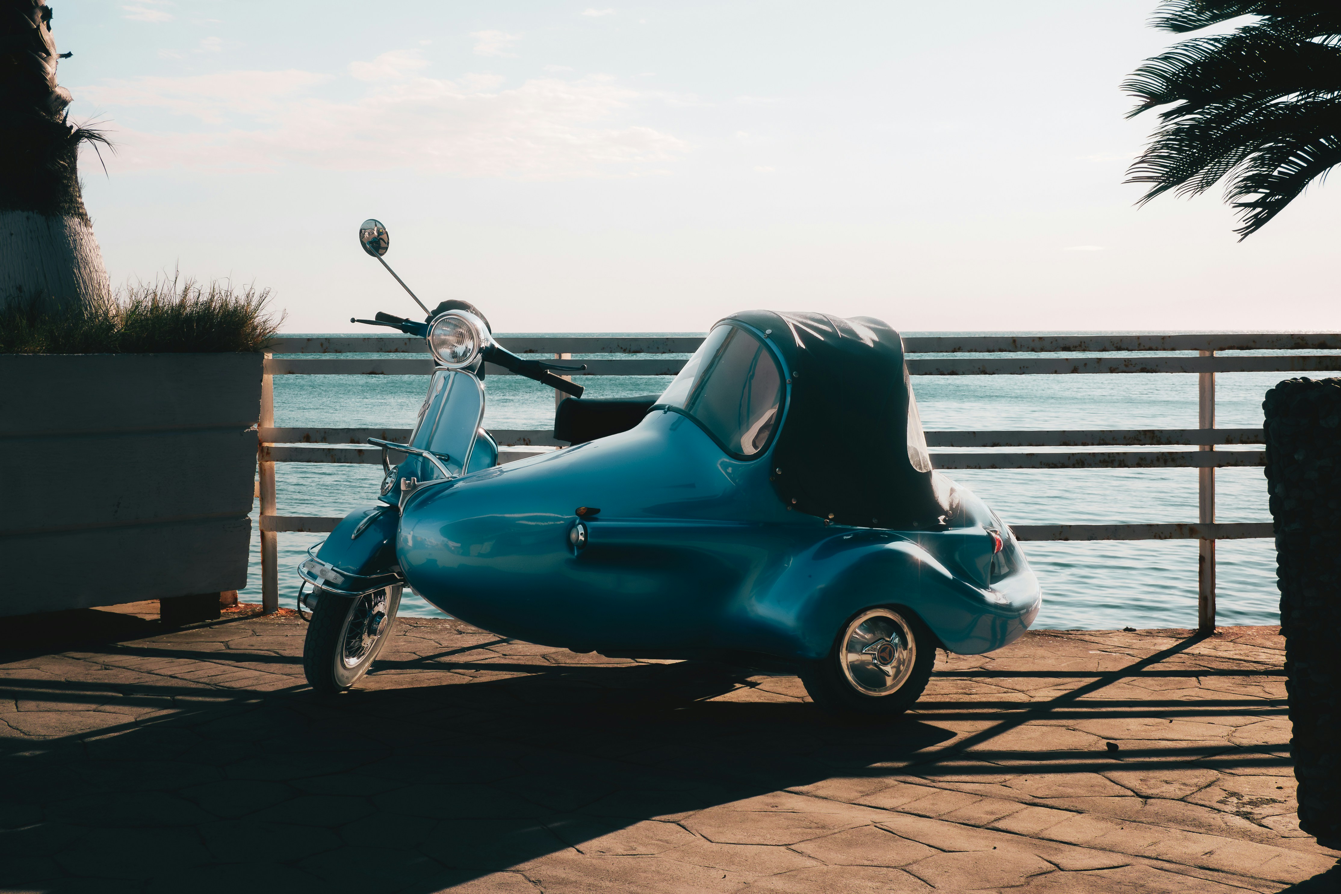 Blue scooter by the sea: a sunny seaside vignette