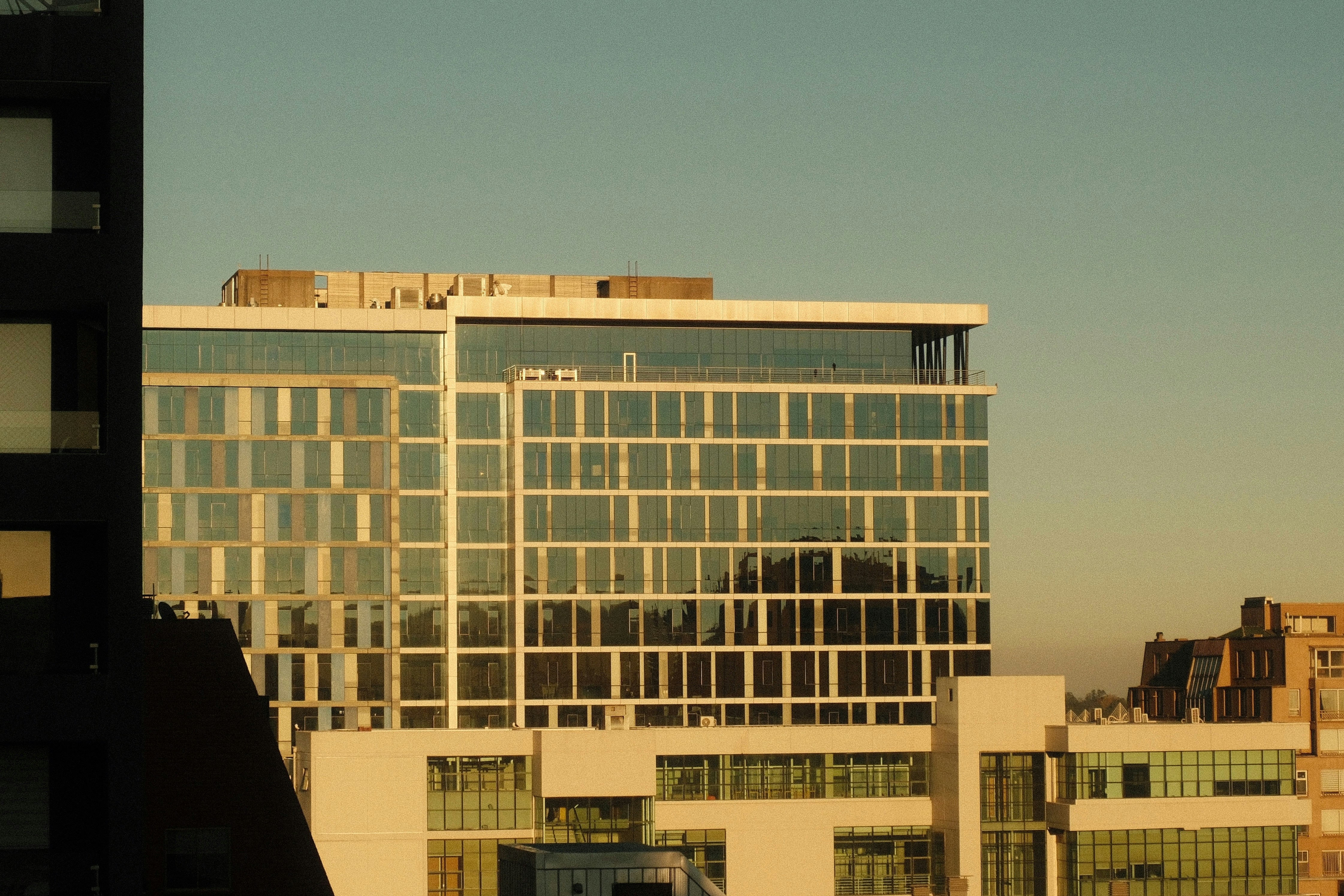 Glass Facade Echo: A Modern Cityscape at Dusk