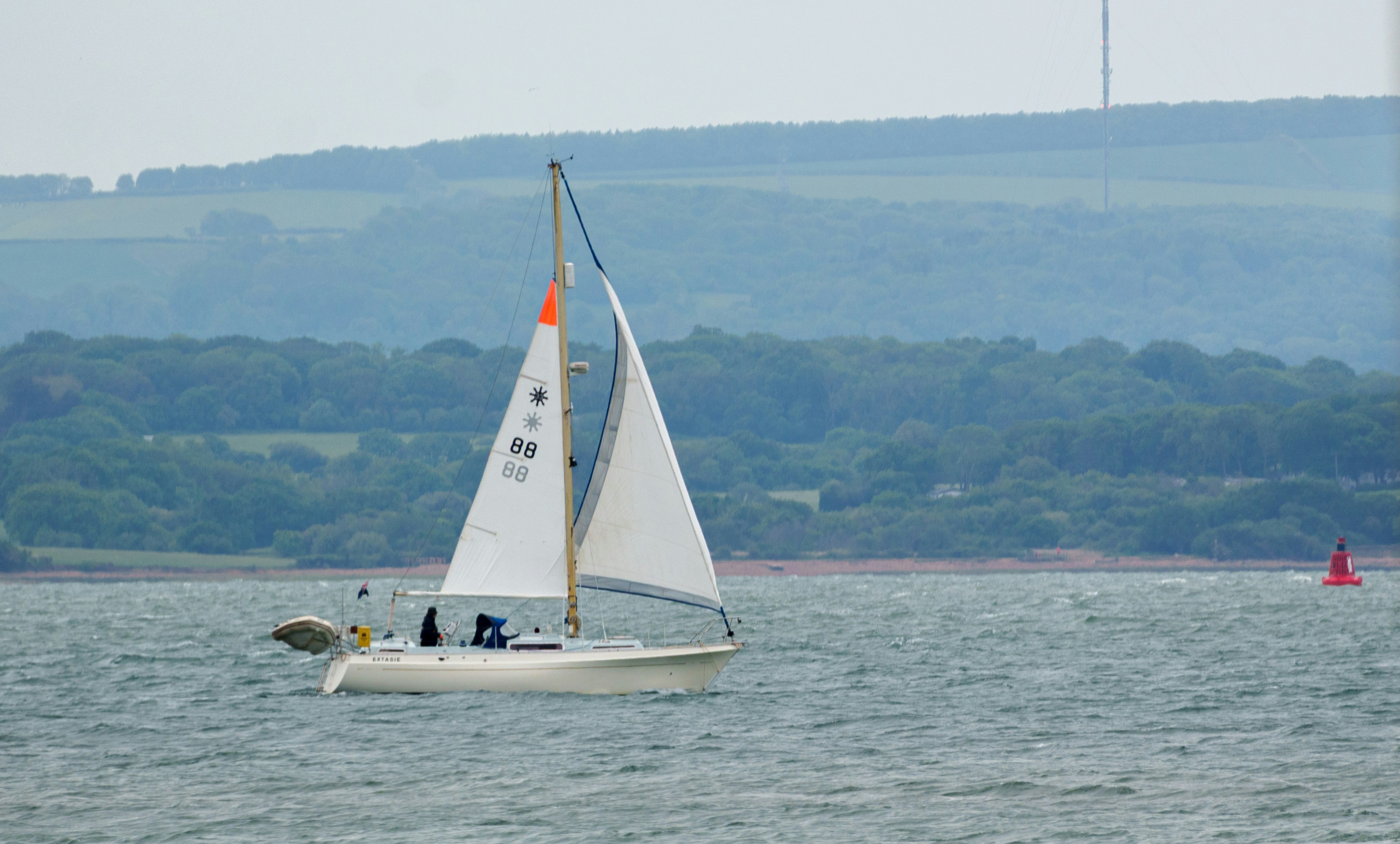 Sailboat Speaks in Calm Water Under Open Sky