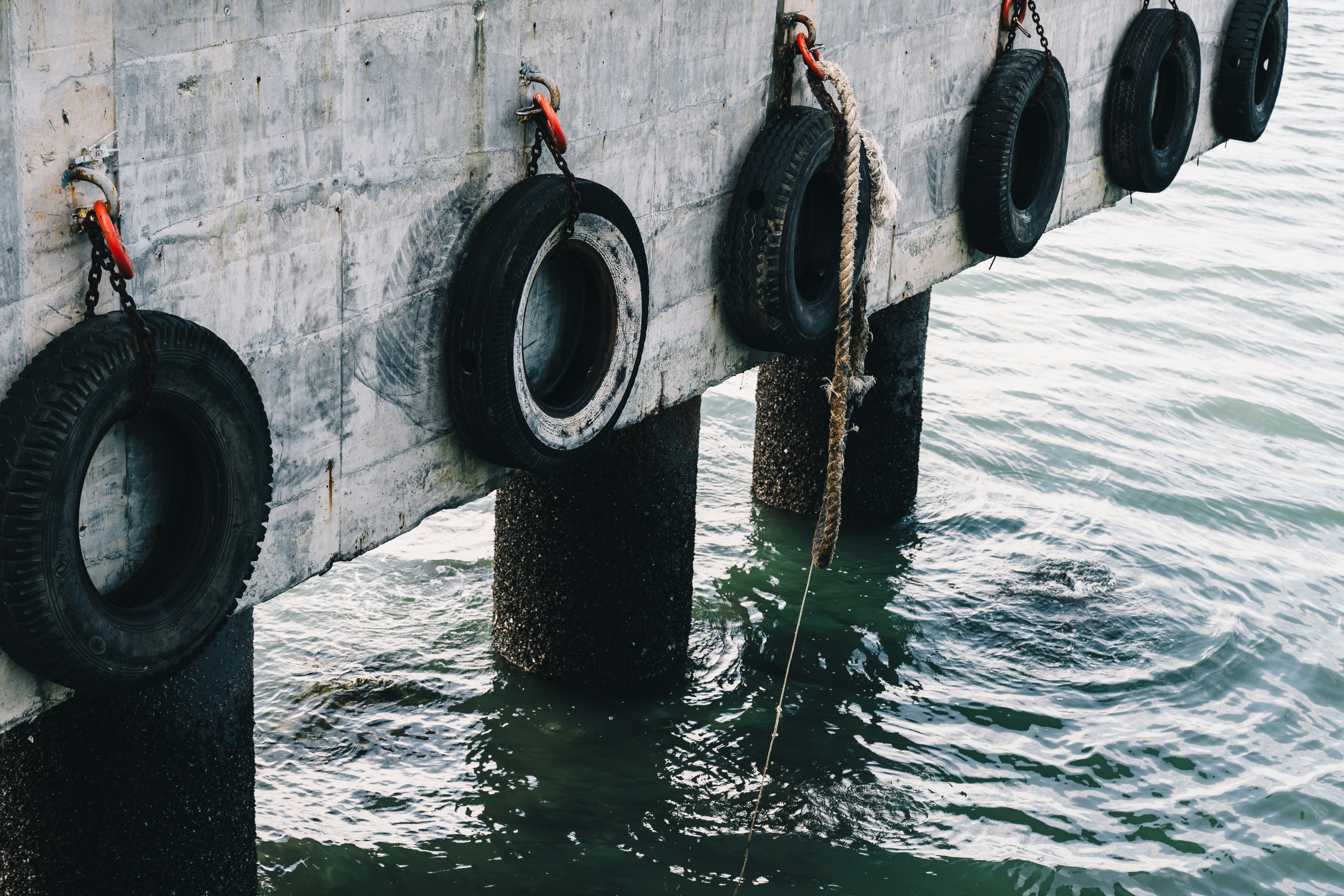 Tires as Buoyant Sentinels: A Waterfront Pier Moment
