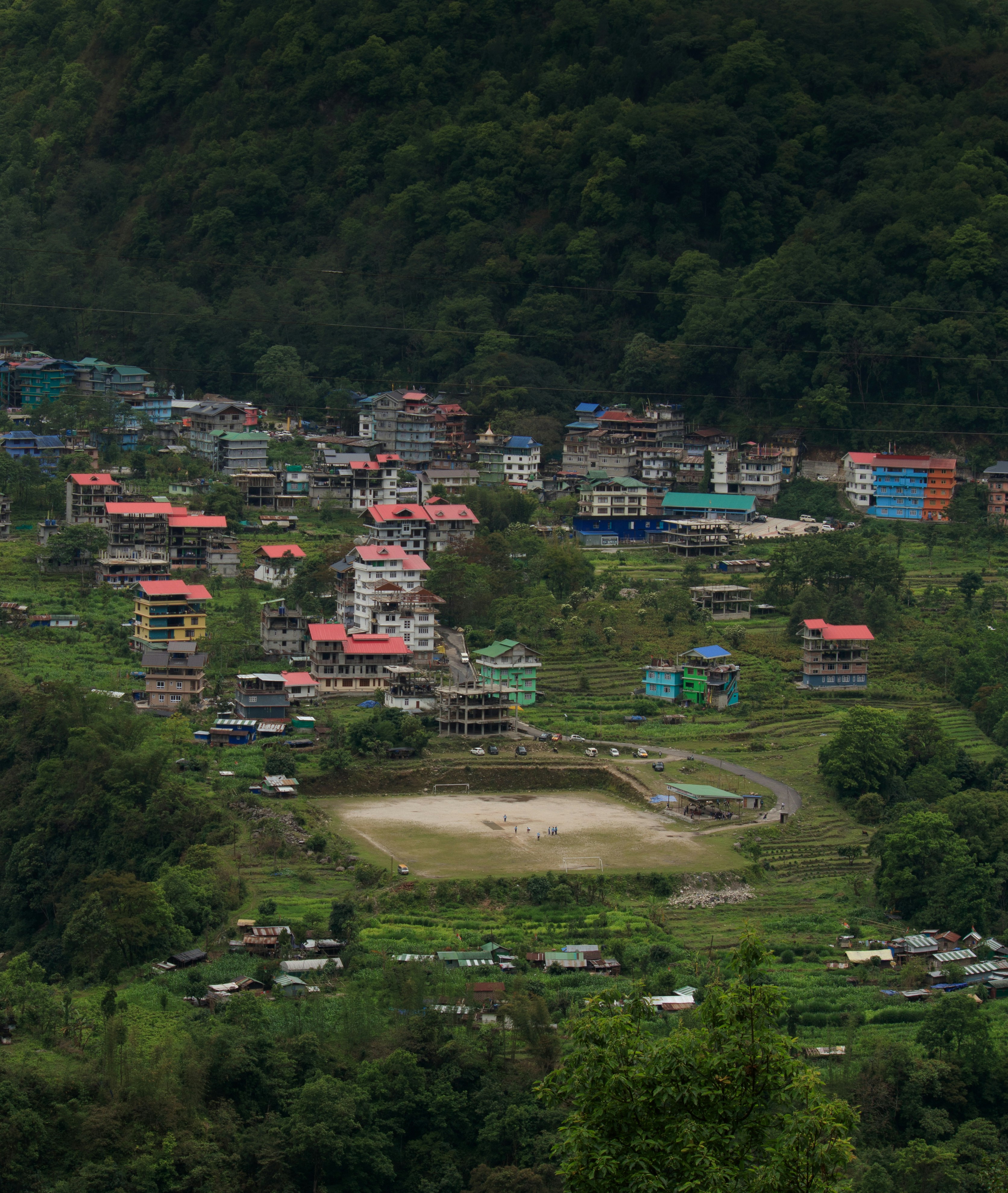 Terraced Village Nestled at the Foot of a Green Mountain