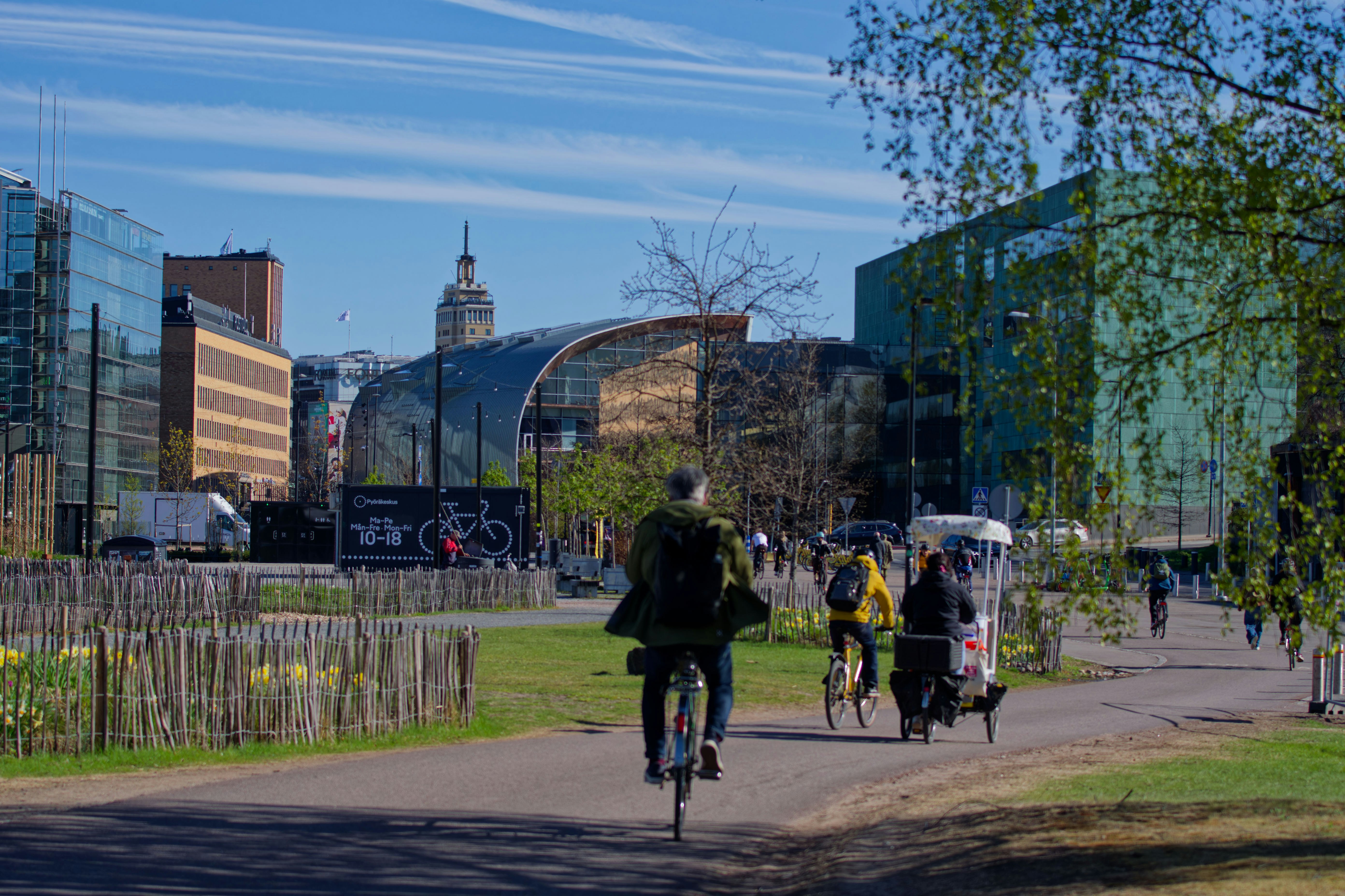 Urban Cyclists on a Sunlit Riverside Path