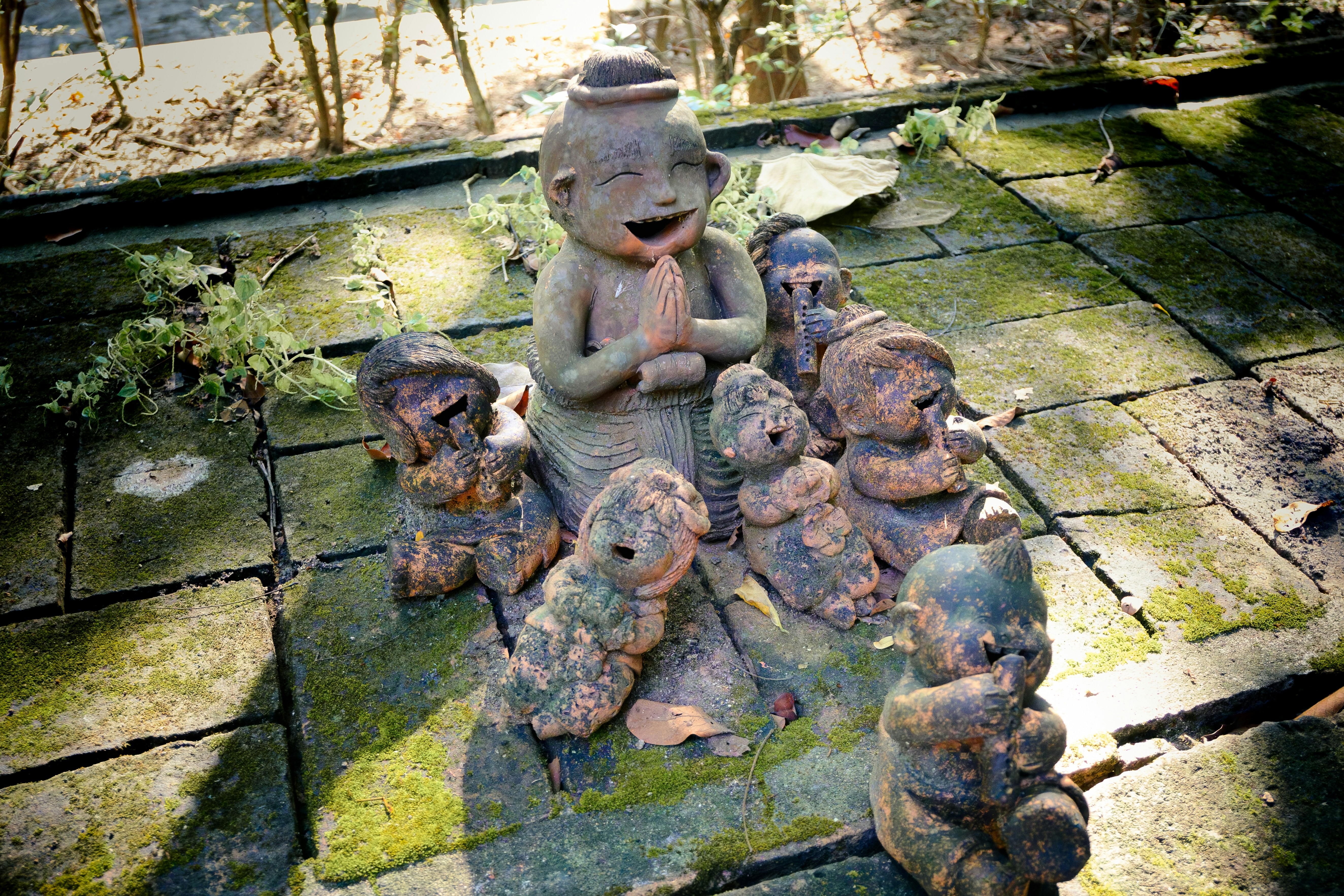 Whispering Monks: Moss-Covered Statues in a Quiet Courtyard