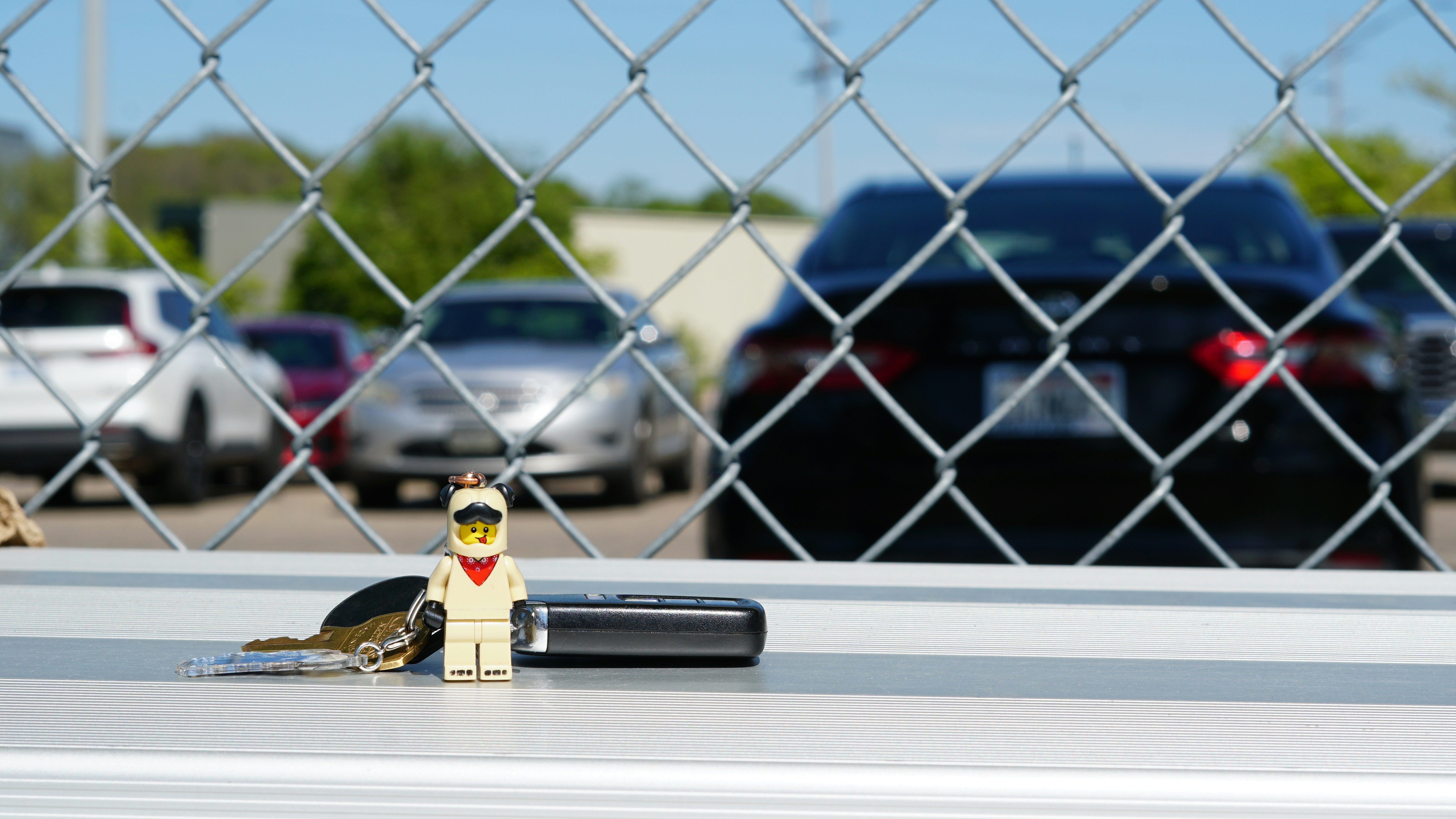 Miniature Sentinel: A LEGO Figurine Guarding Keys on a Car-Deck