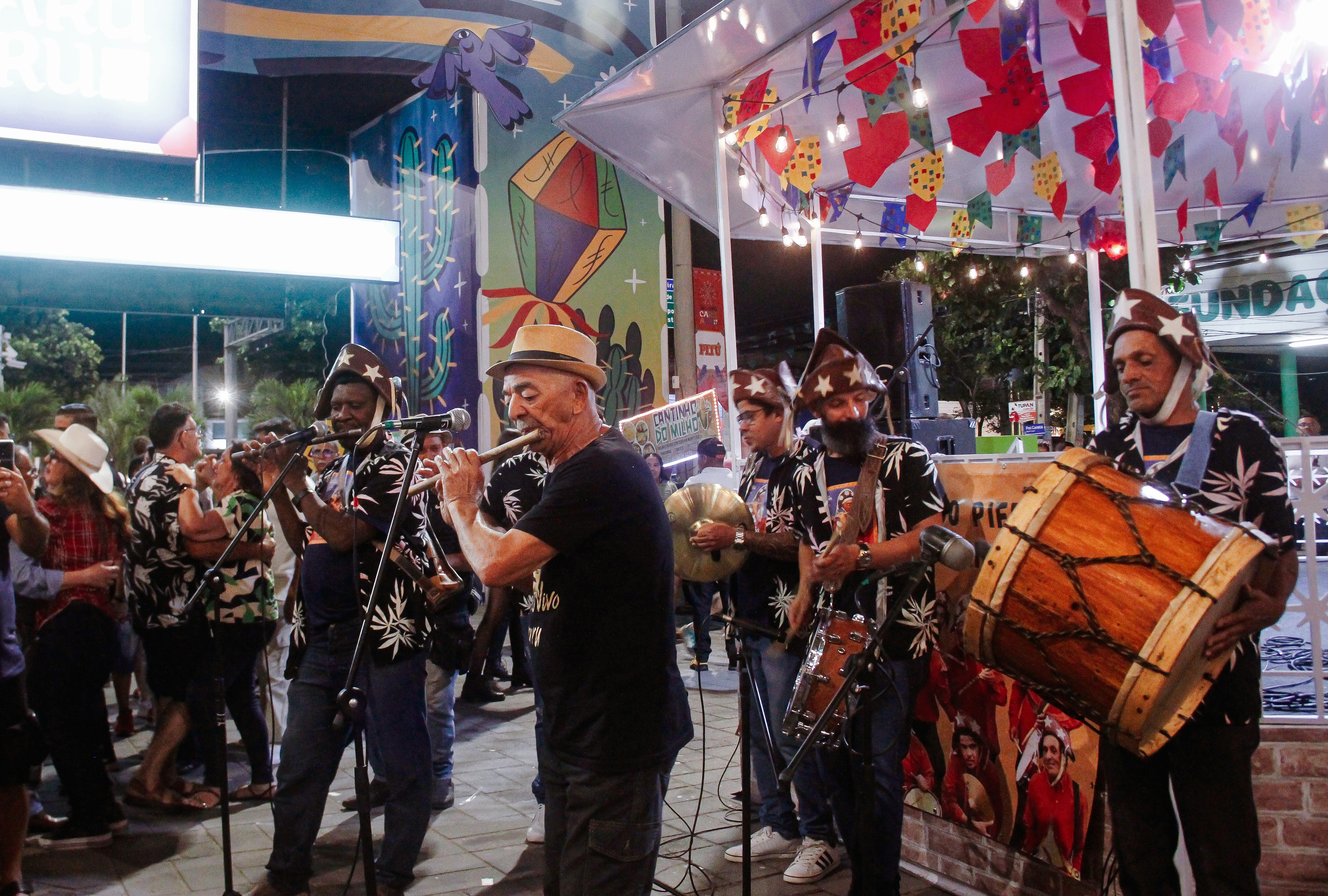 Street Band Cadence Under Colorful Festival Canopy