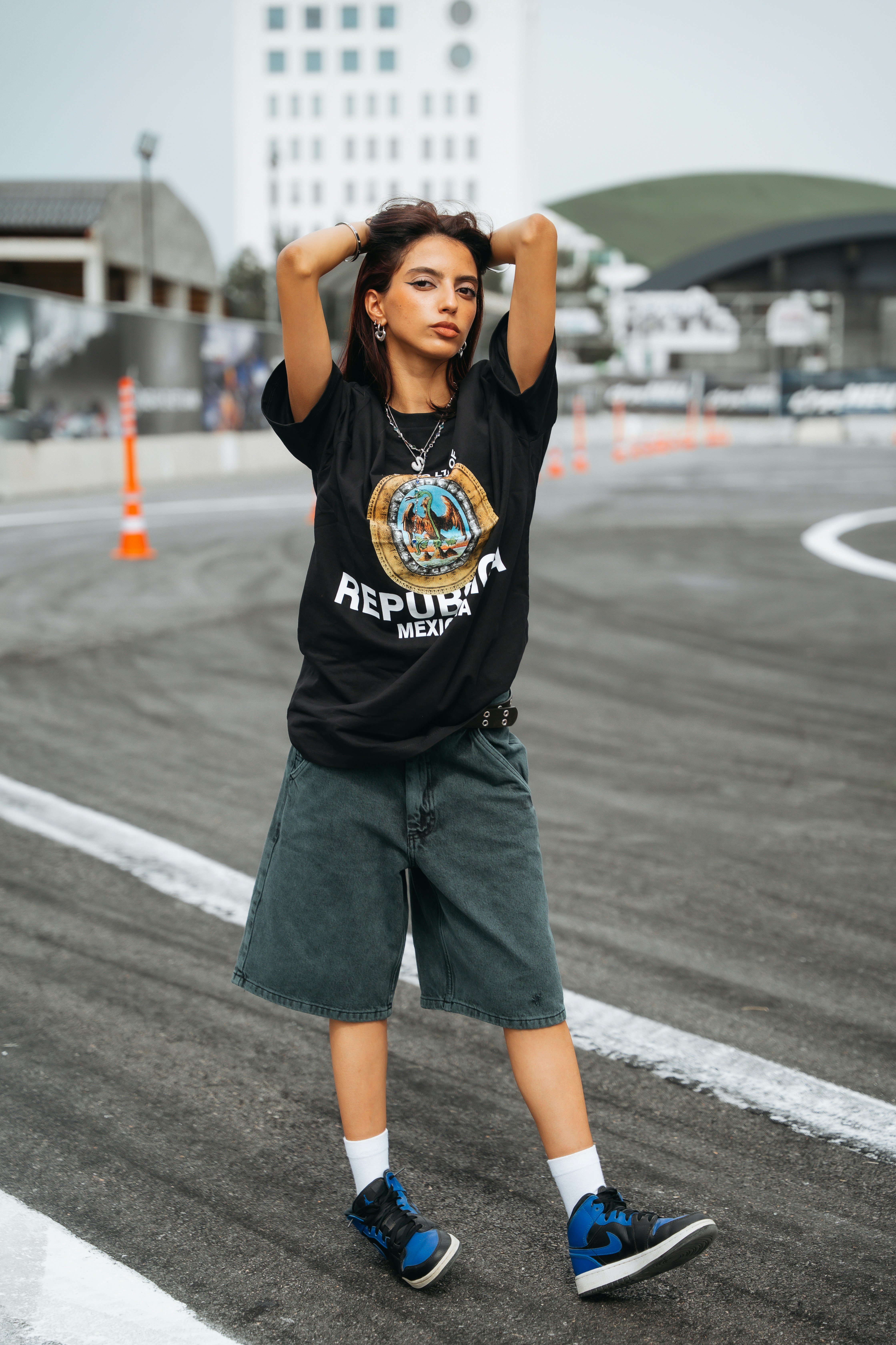 Urban Confidence: A Youthful Stance in a Parked-Road Field