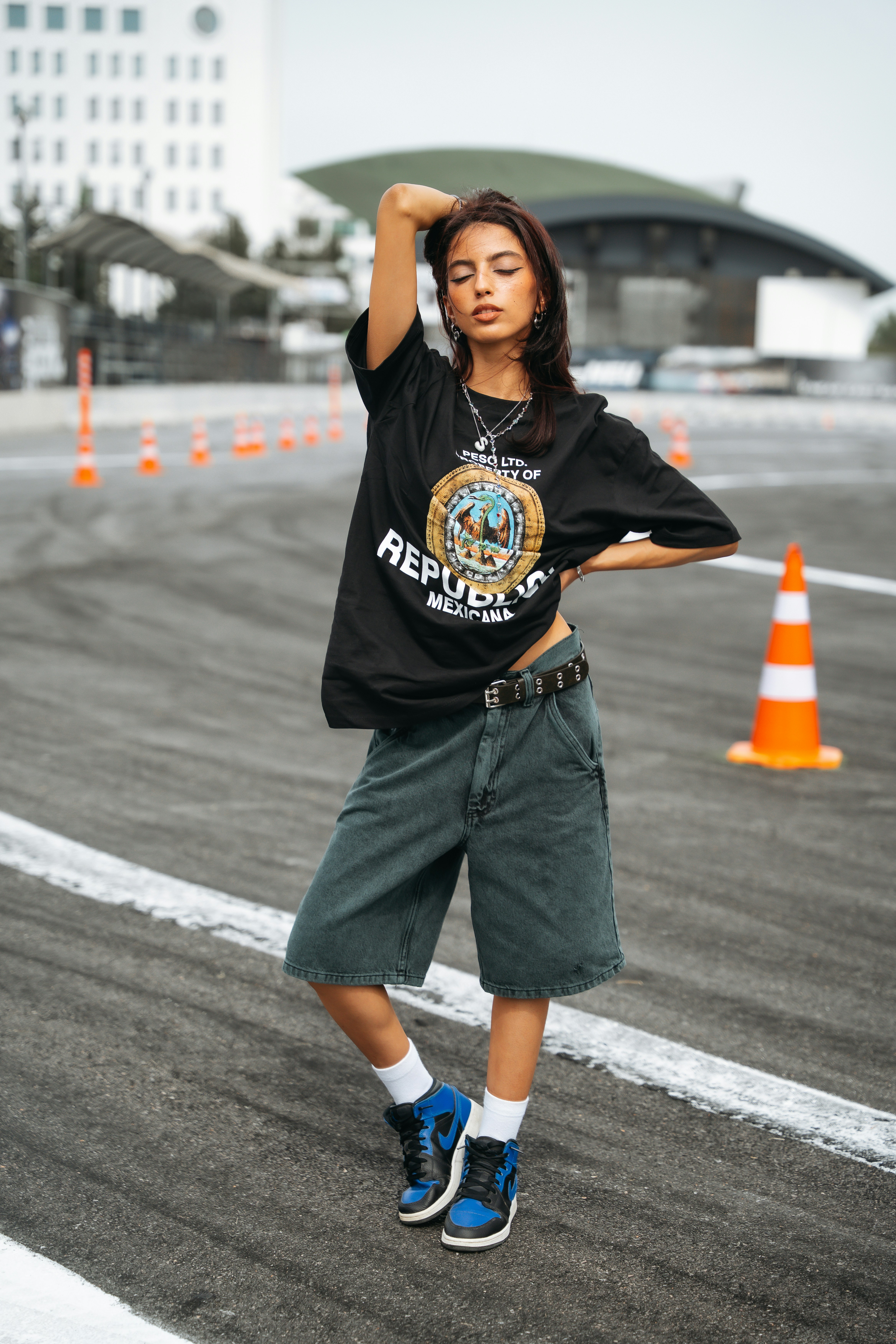 Urban Cool: A confident pose amid a temporary roadway stage