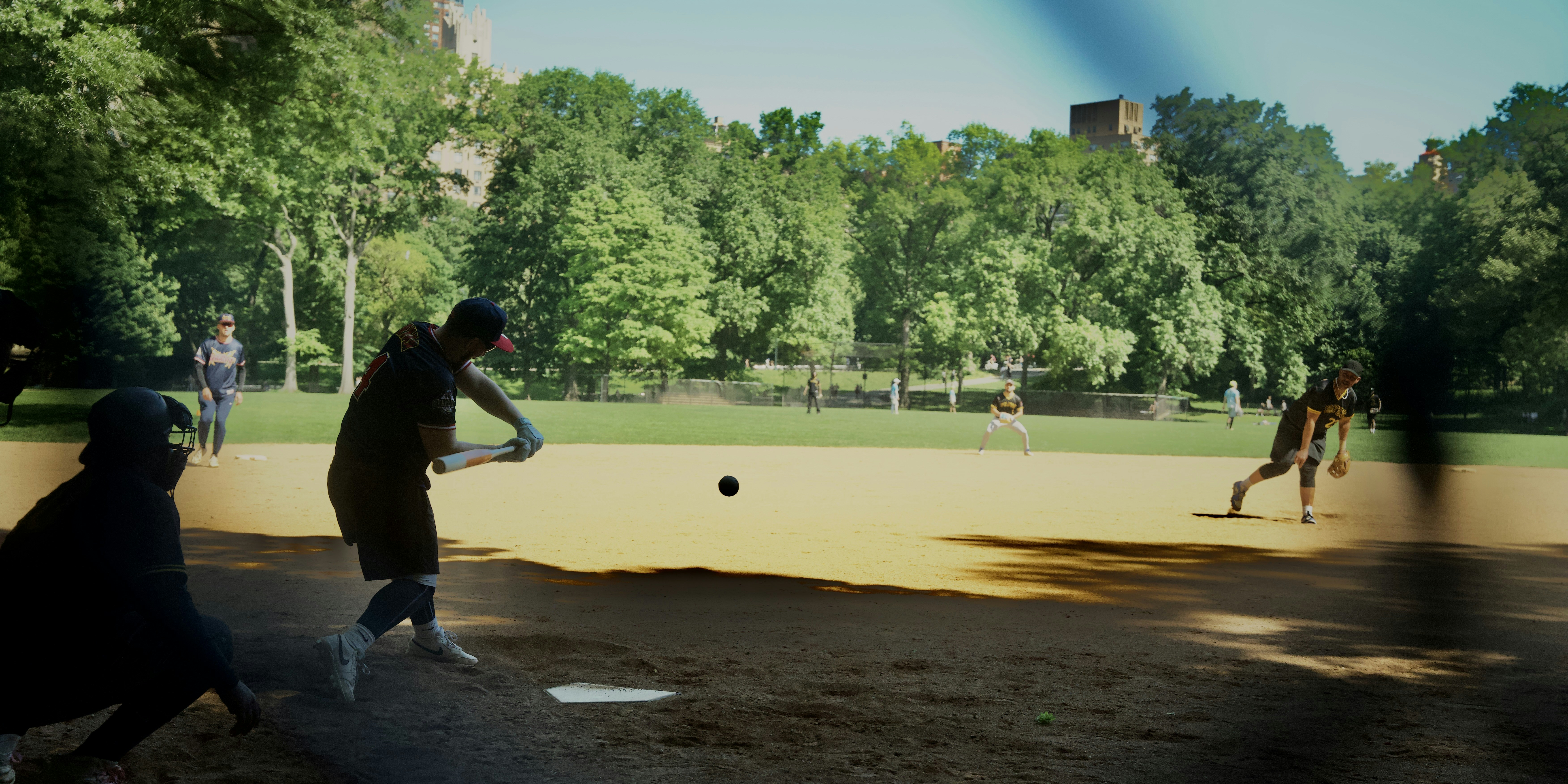 Baseball game in progress on a sunny day.