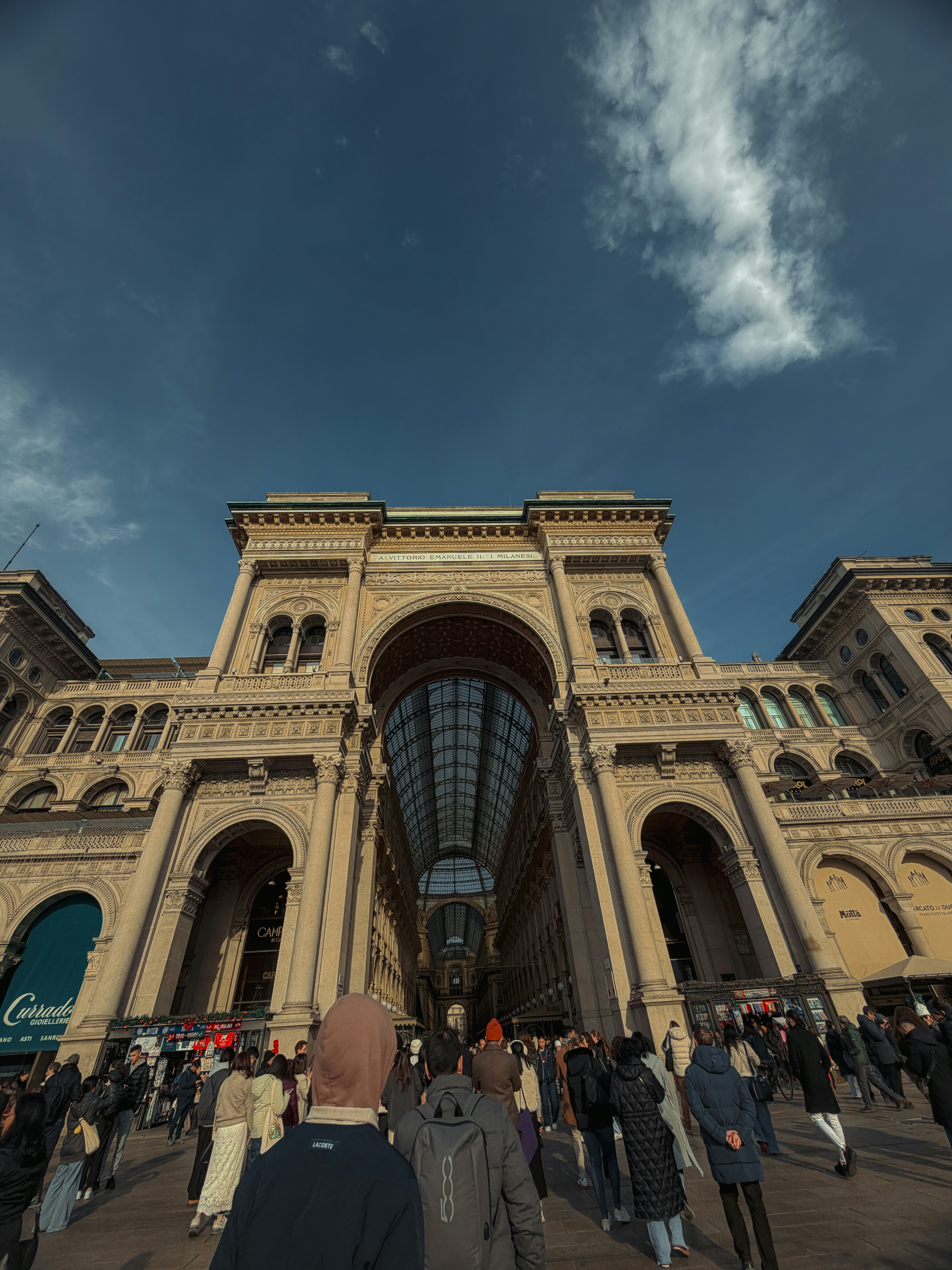 Archway of Time: Courtyard Gateway Beneath a Sky of Blue