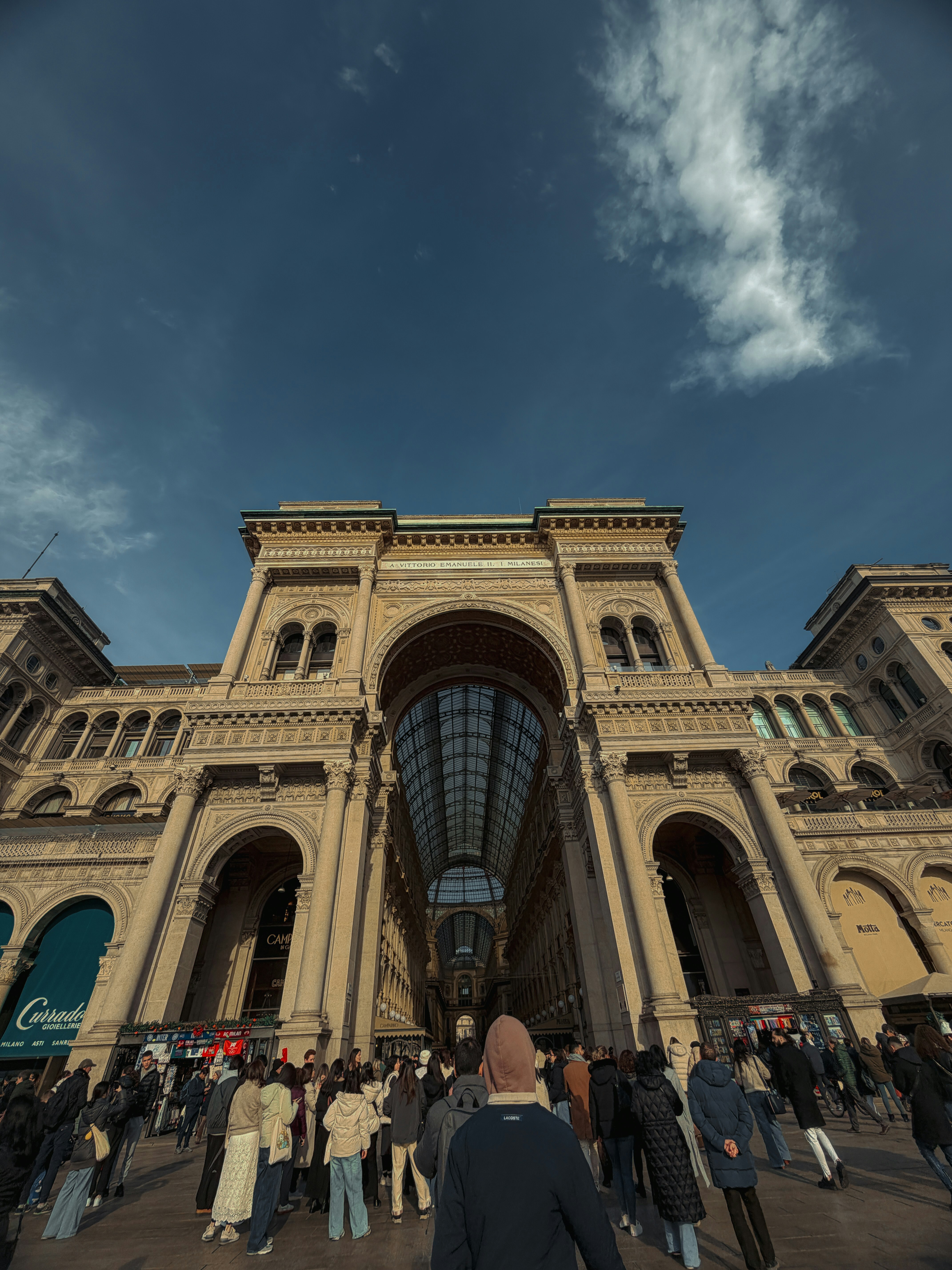 Archway to the City: A Towering Gateway Framed by a Busy Plazal