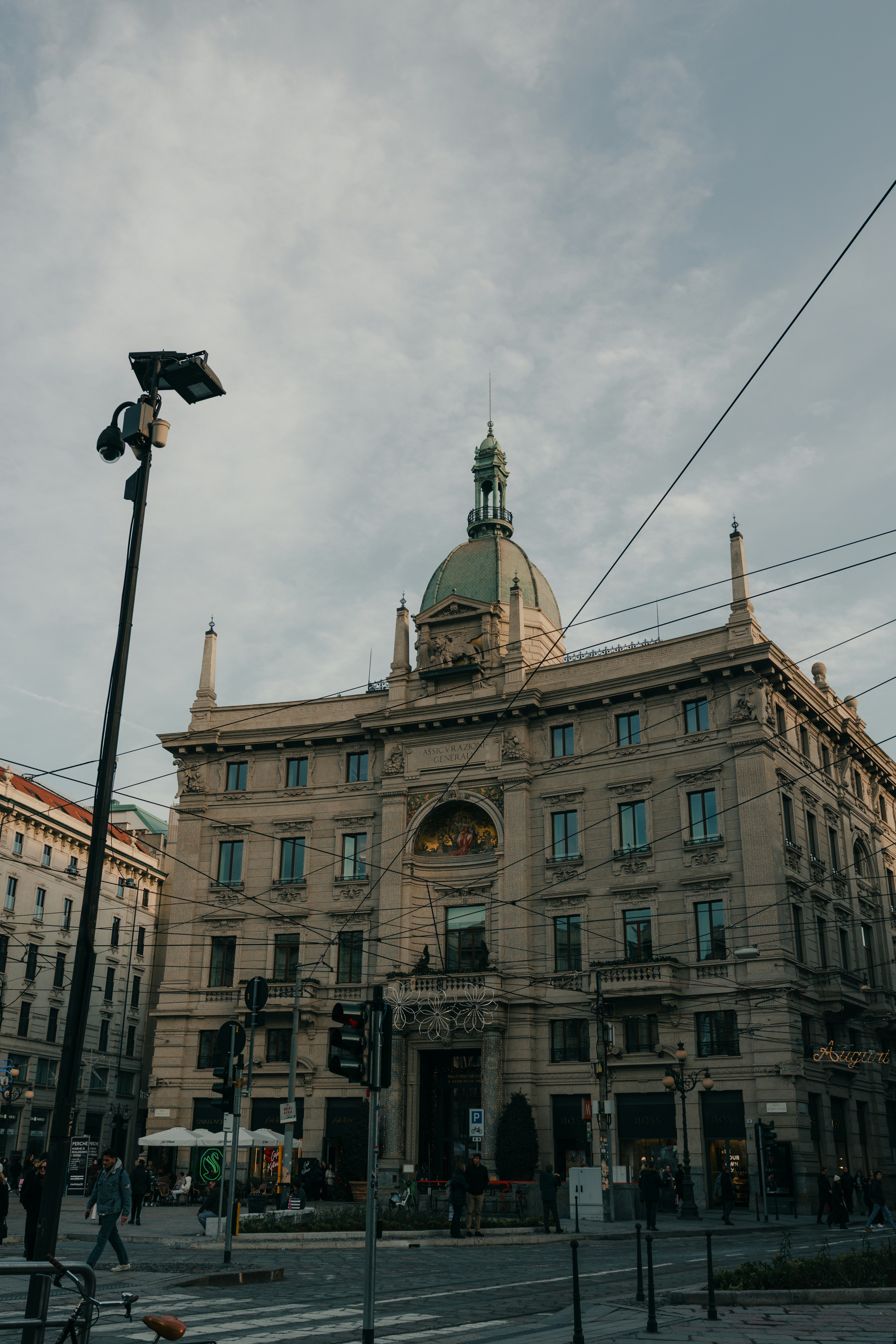 Facade of a grand urban opera house under a pale blue sky