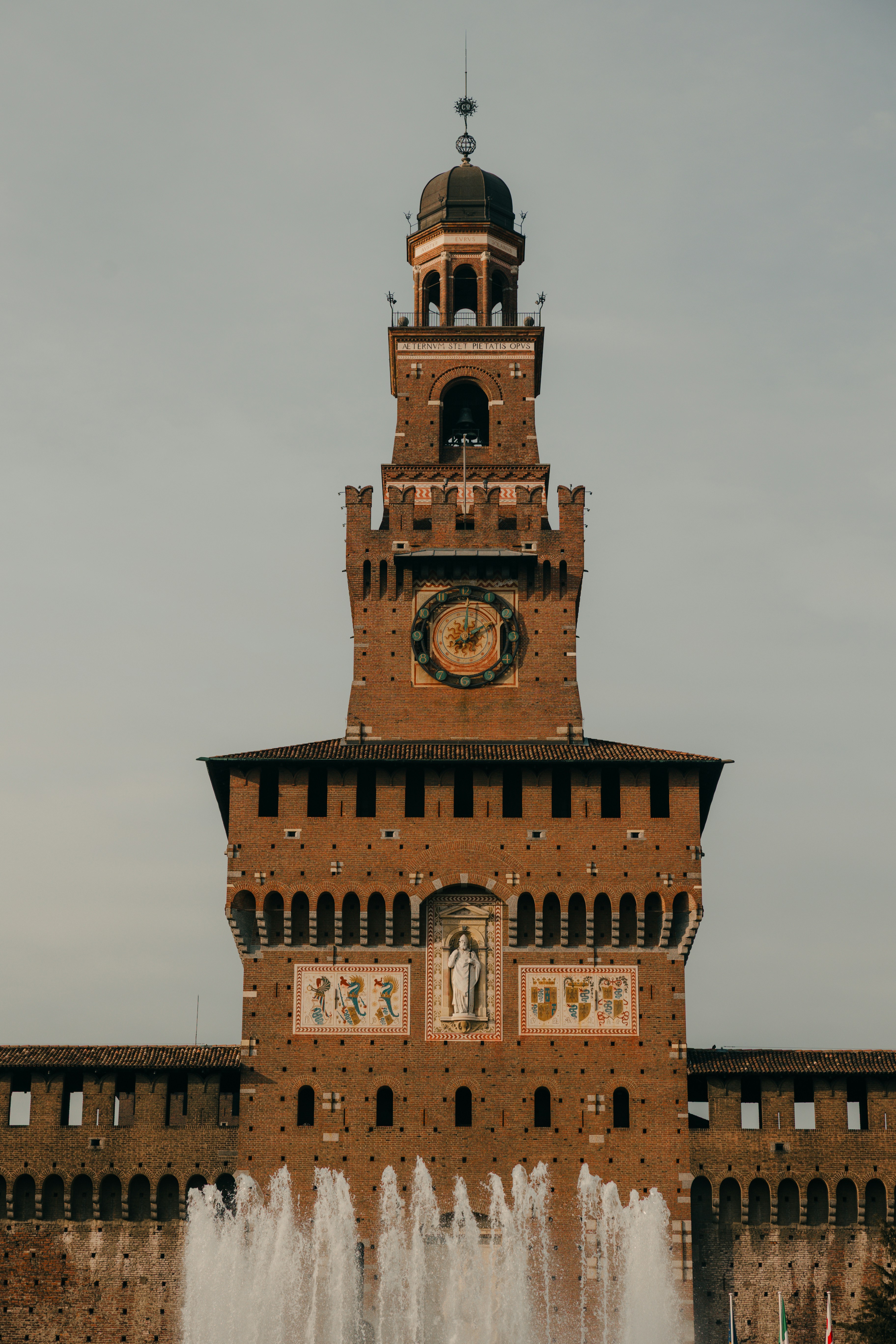 Towering Brick Clock Gate: A Medieval Facade Reaching toward the Sky