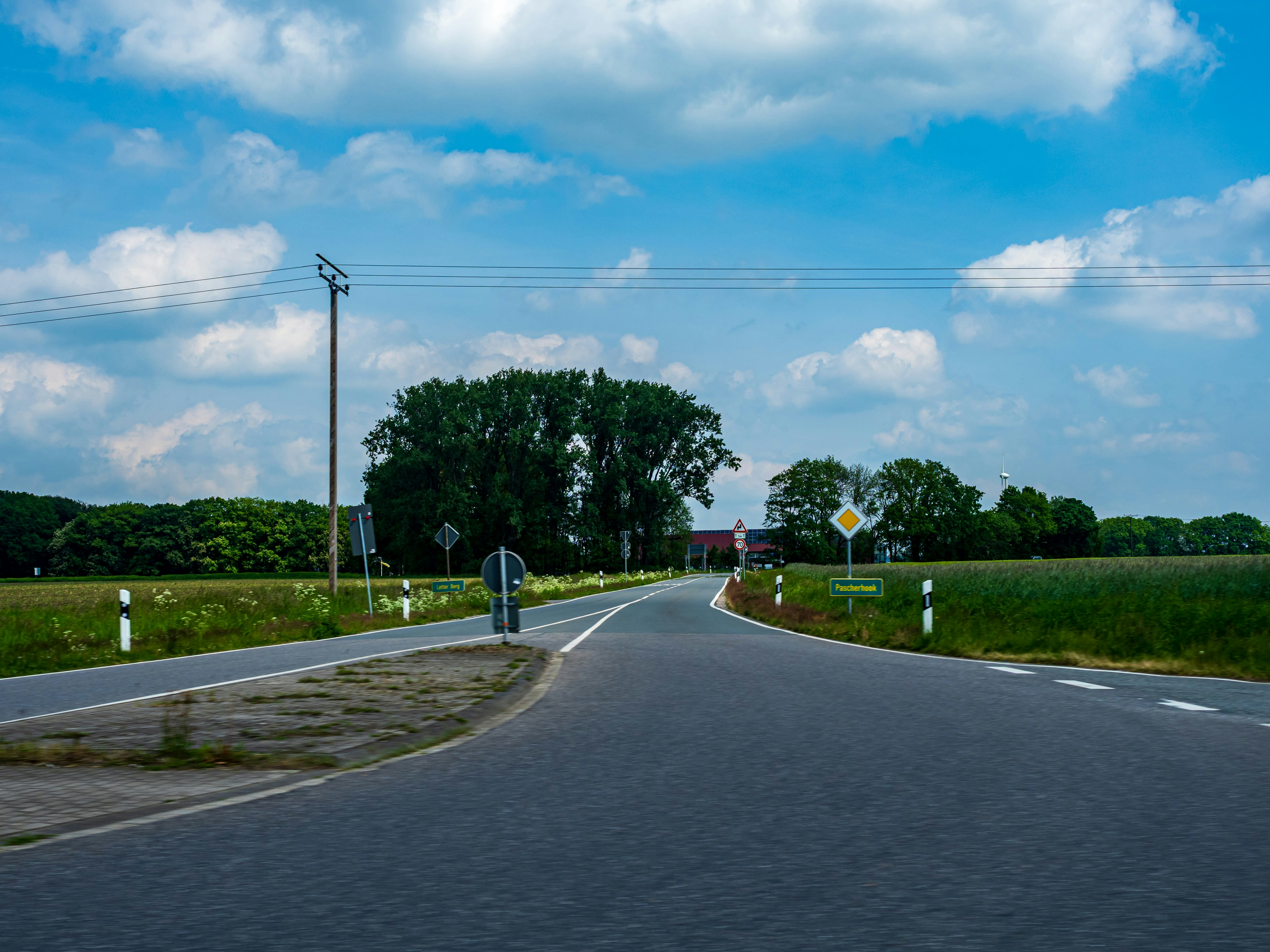 Midday Turn: A Quiet Crossroad Opens to Greenfields