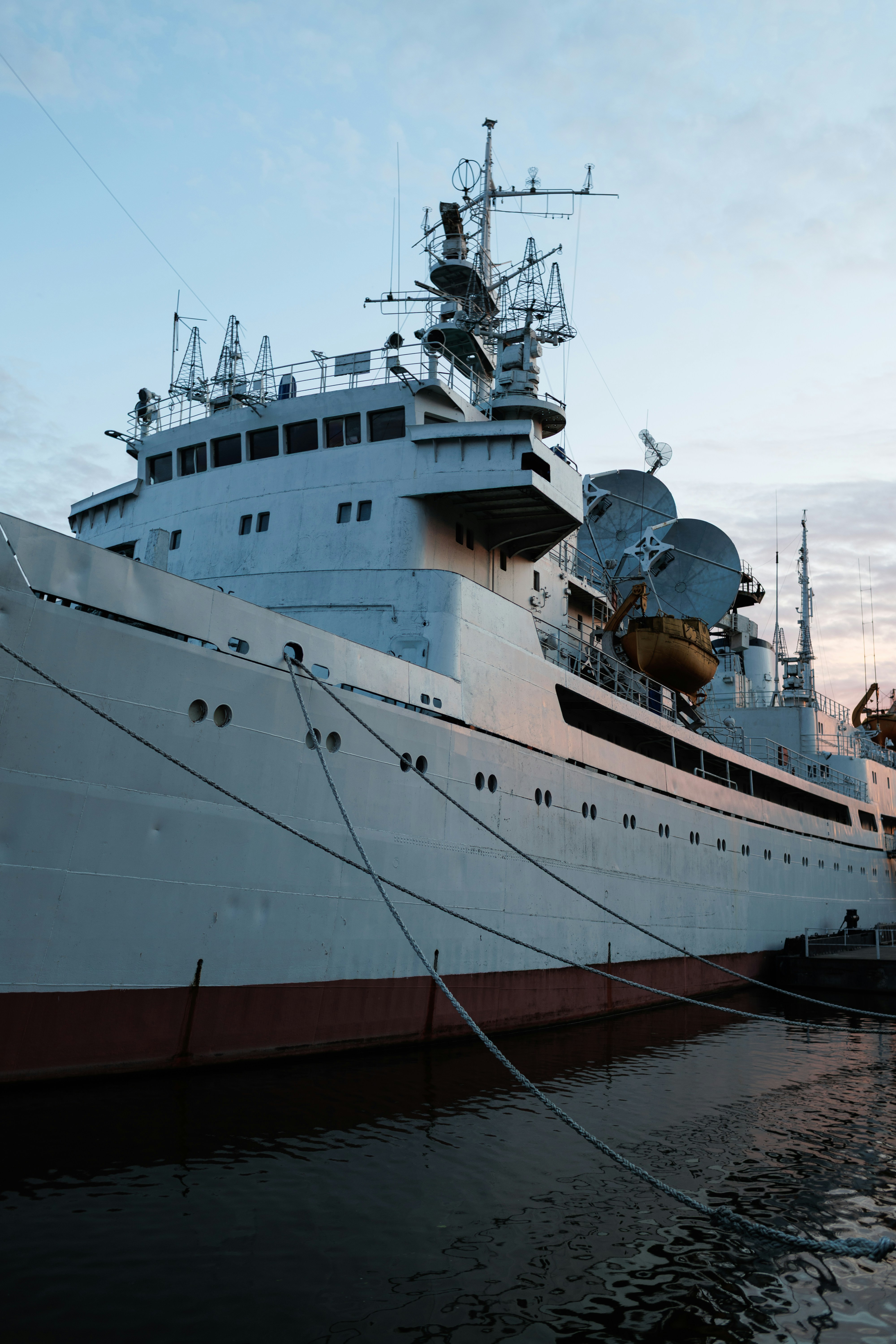 Midship Majesty: The Warship at Dusk Anchored in Quiet Waters