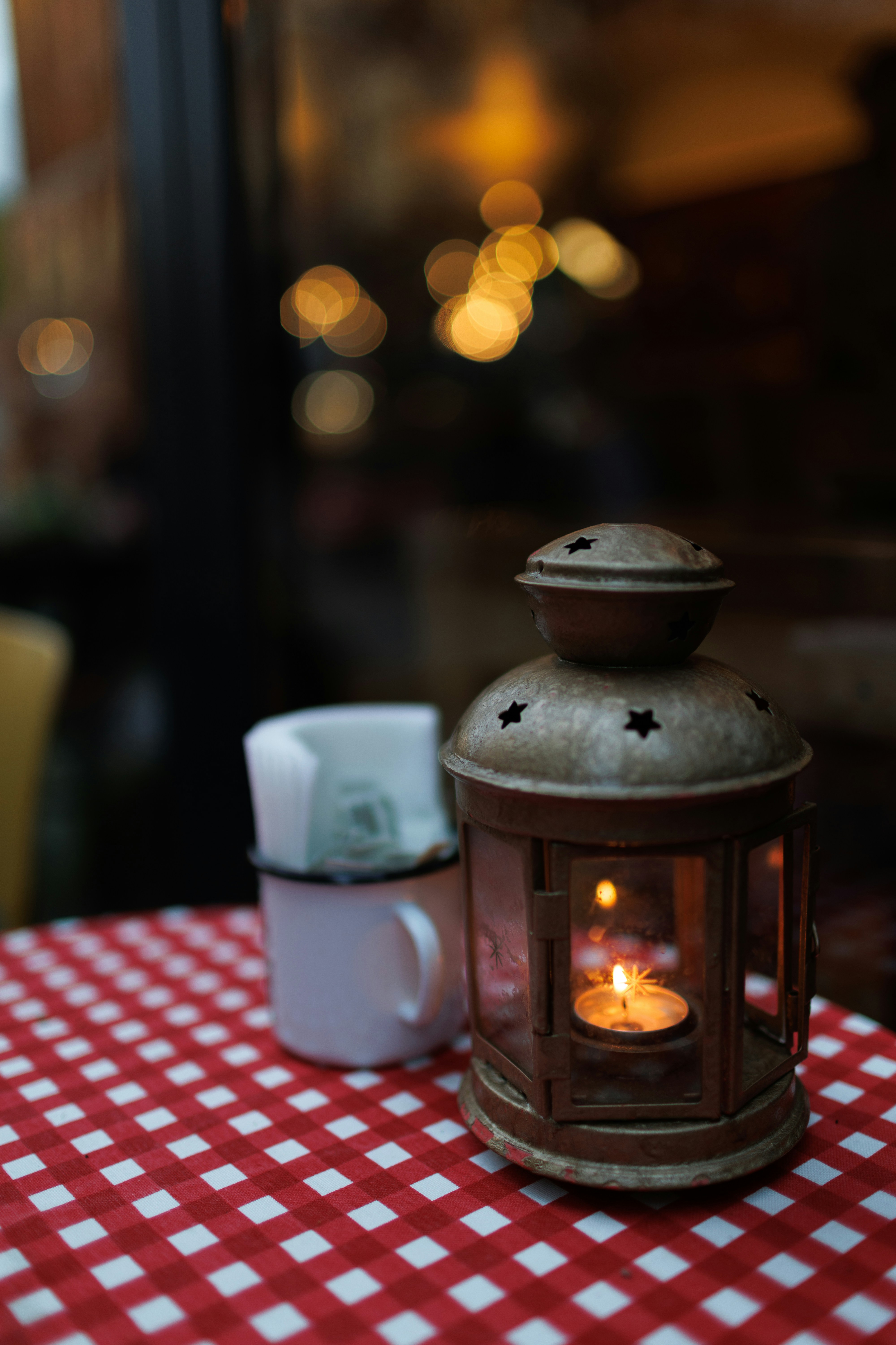 Lantern Glow on a Red-Checked Table