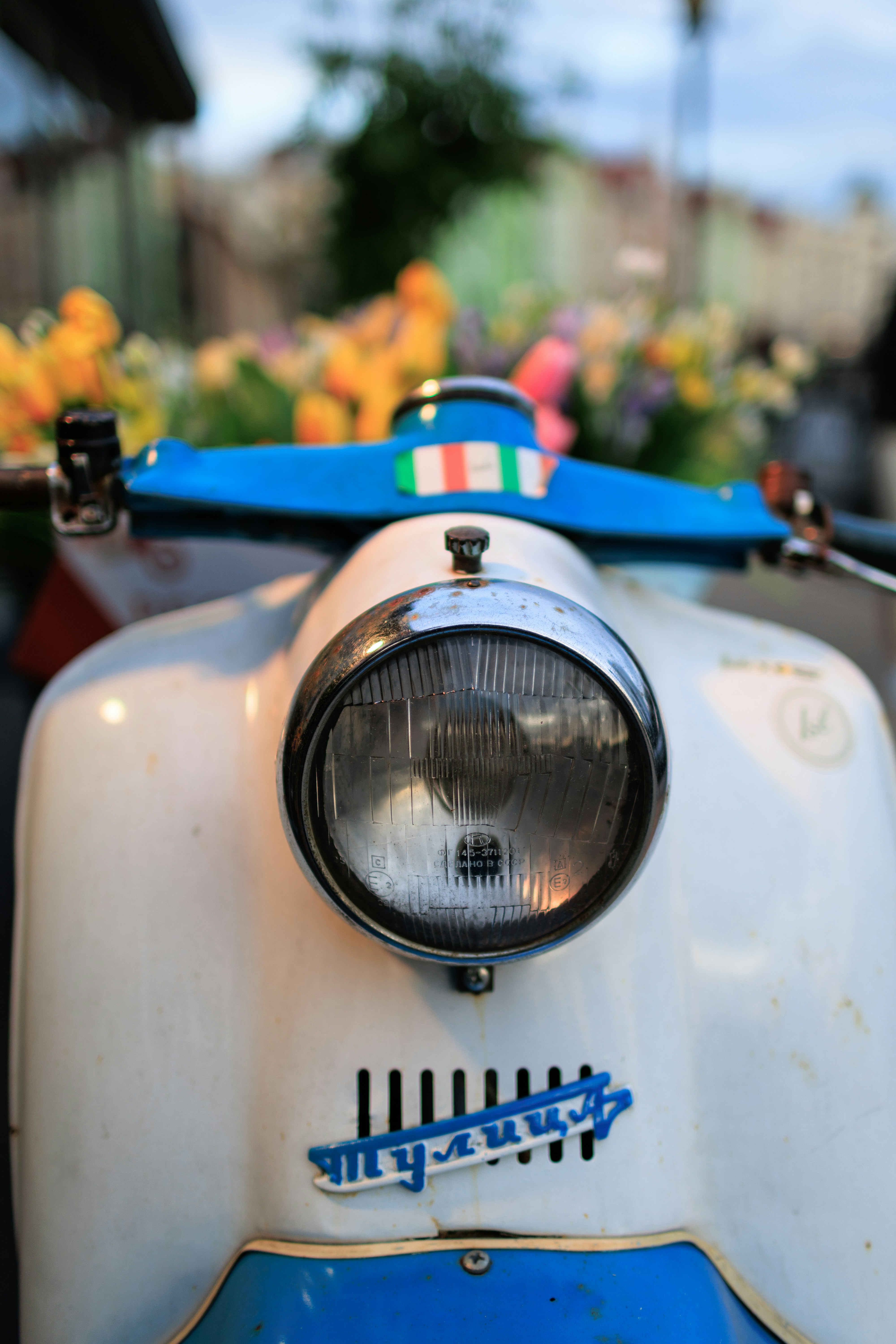 Vintage Vespa Headlight: A Portrait in Turquoise and Chrome