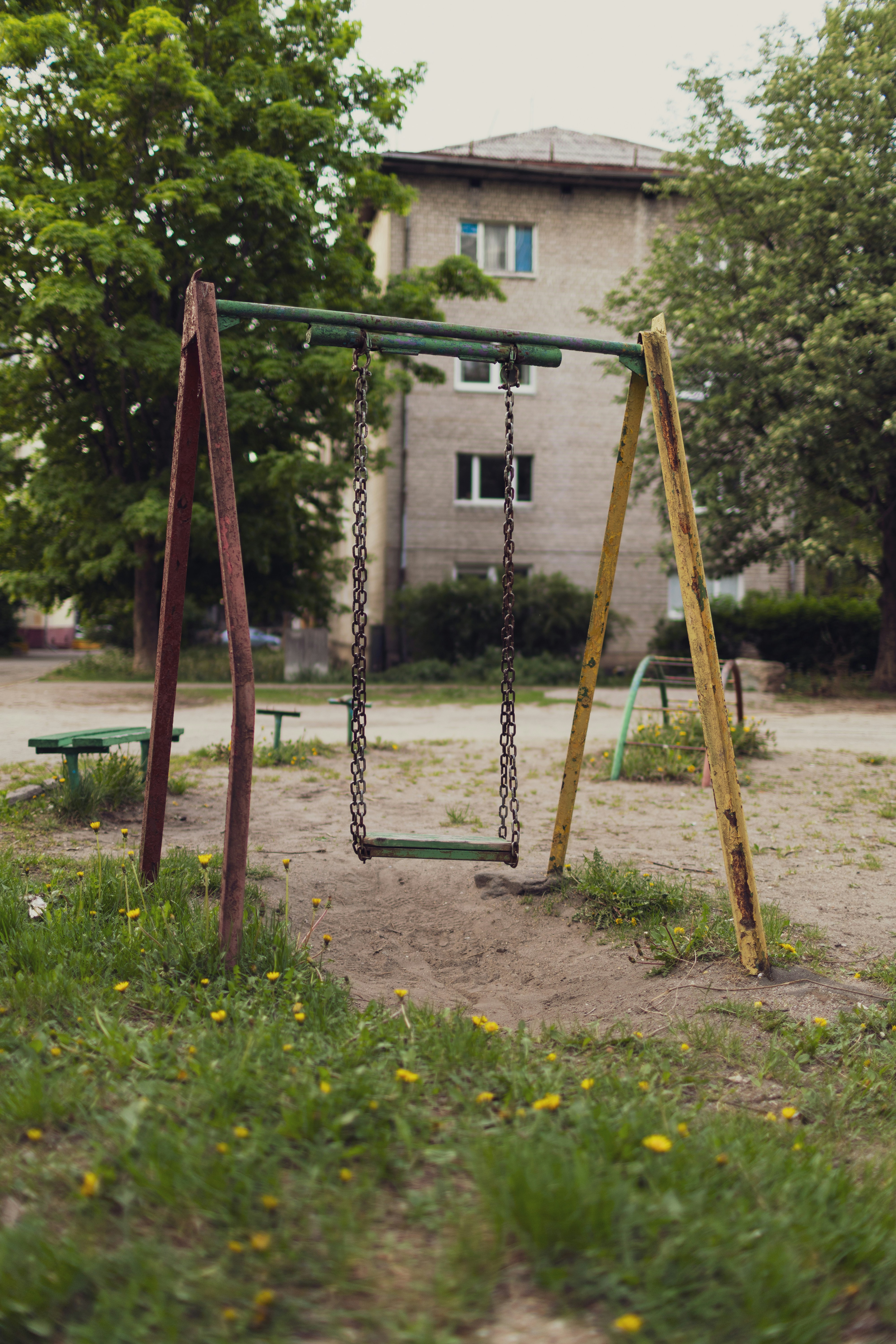 Sunlit Swing Set in a Quiet Playground Garden