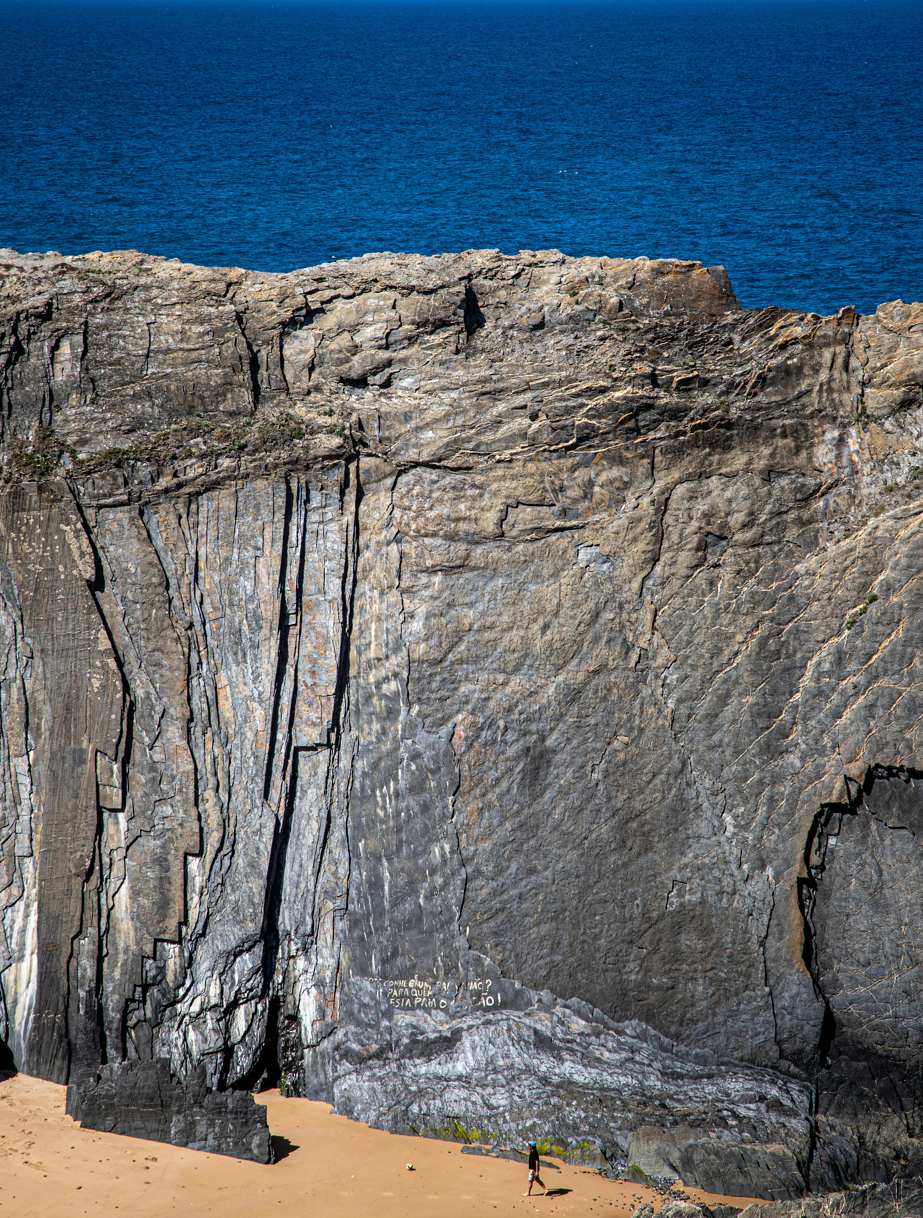 Ocean Cliff Portrait: A Sailor’s Path at the Base of Rugged Bedrock