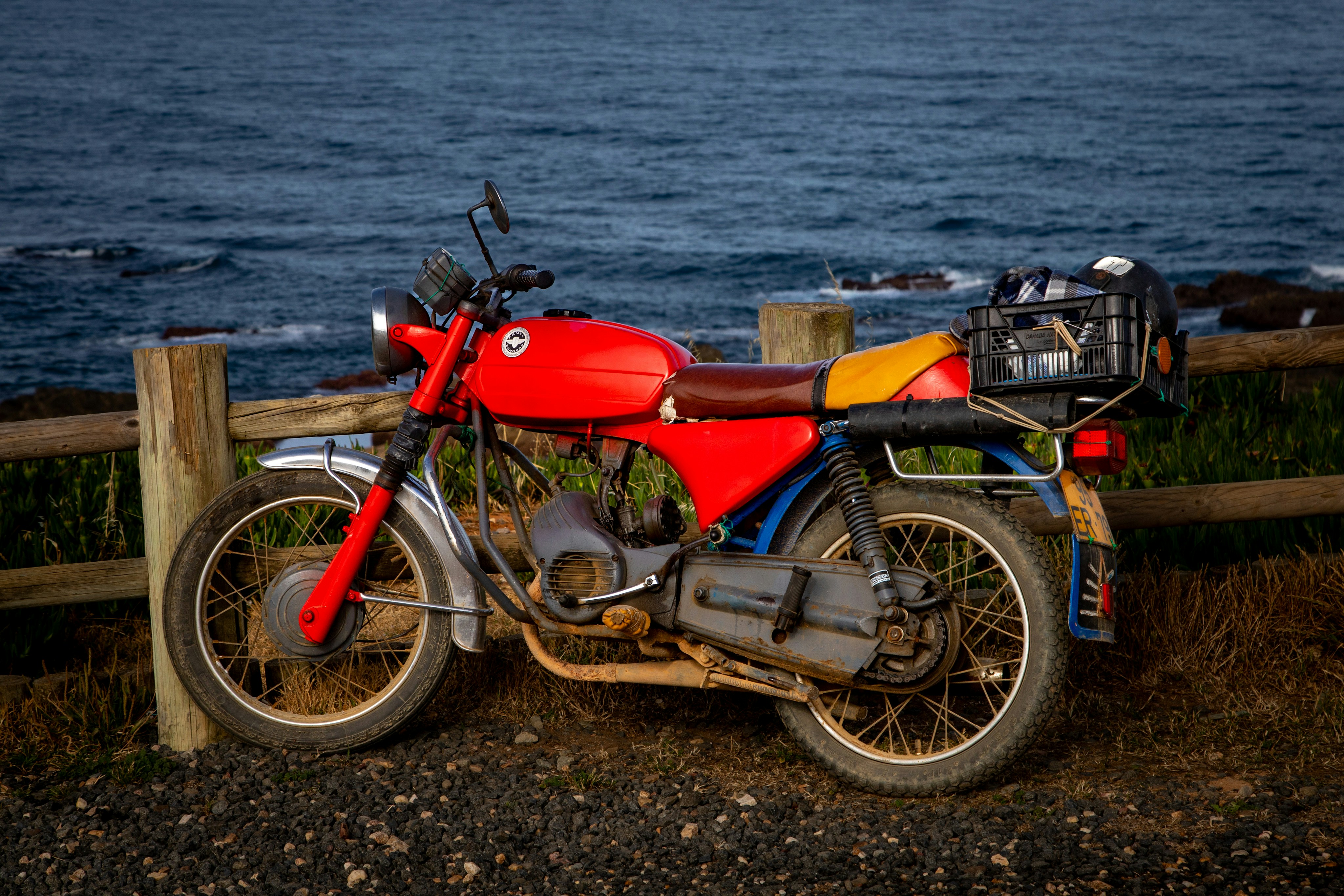Red Vintage Motorcycle by the Sea Gate