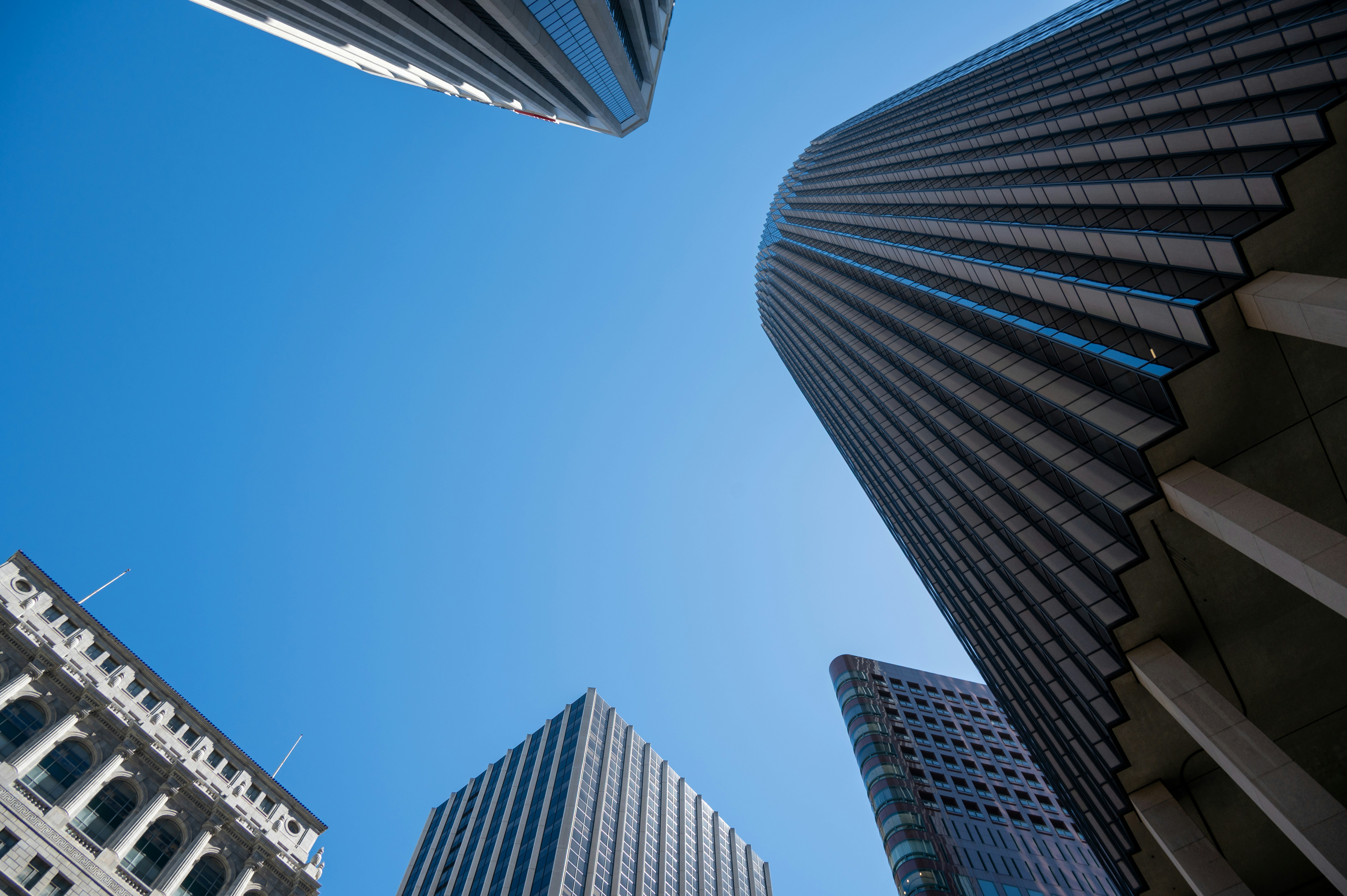 Skyscrapers Pointing to a Clear Blue: A Low-Angle Urban Convergence