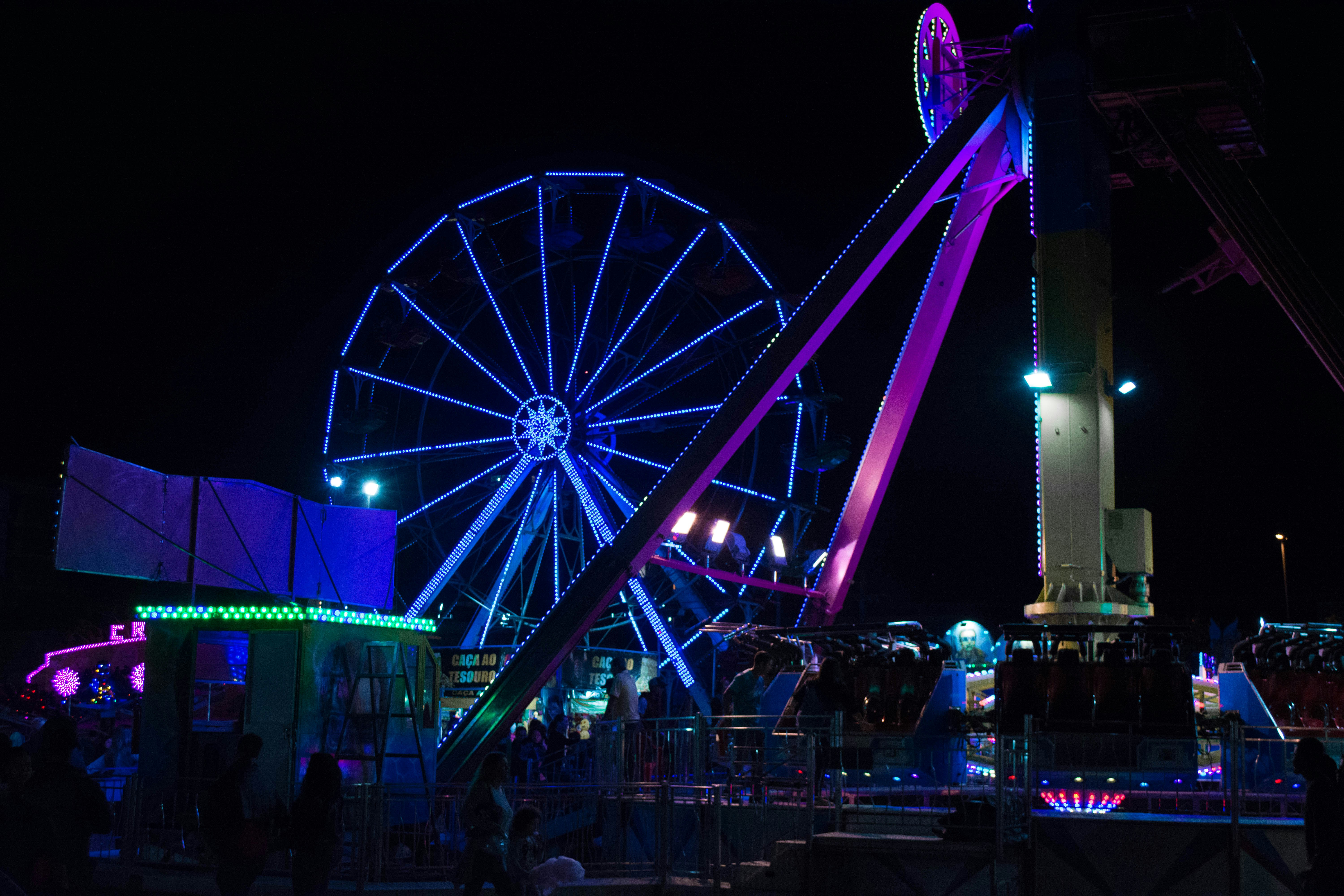 Neon Nightride: Ferris Wheel Glistens Over a Quiet Amusement Park