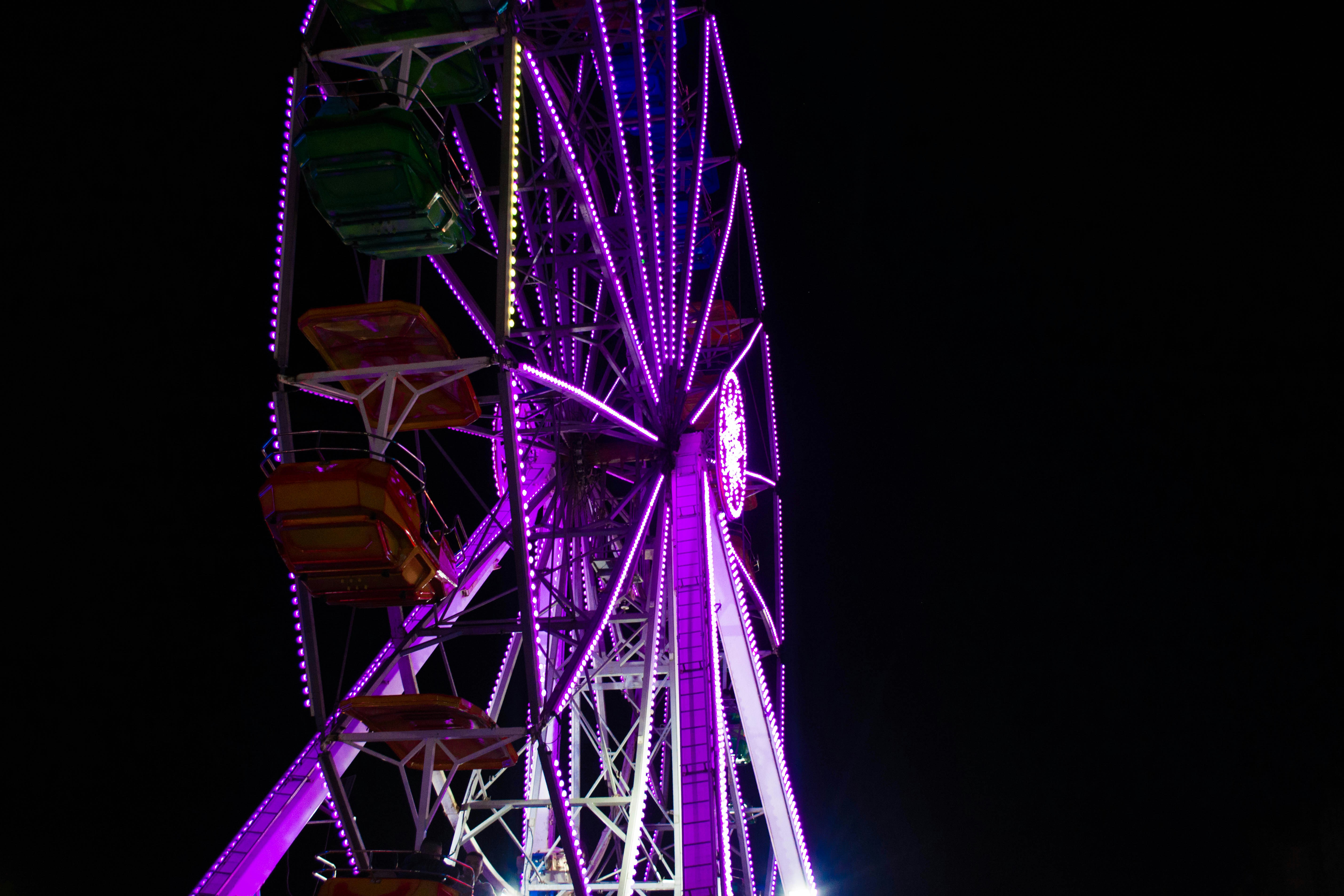 Neon Nightwheel: A Ferris Wheel Glowing in Purple and Violet