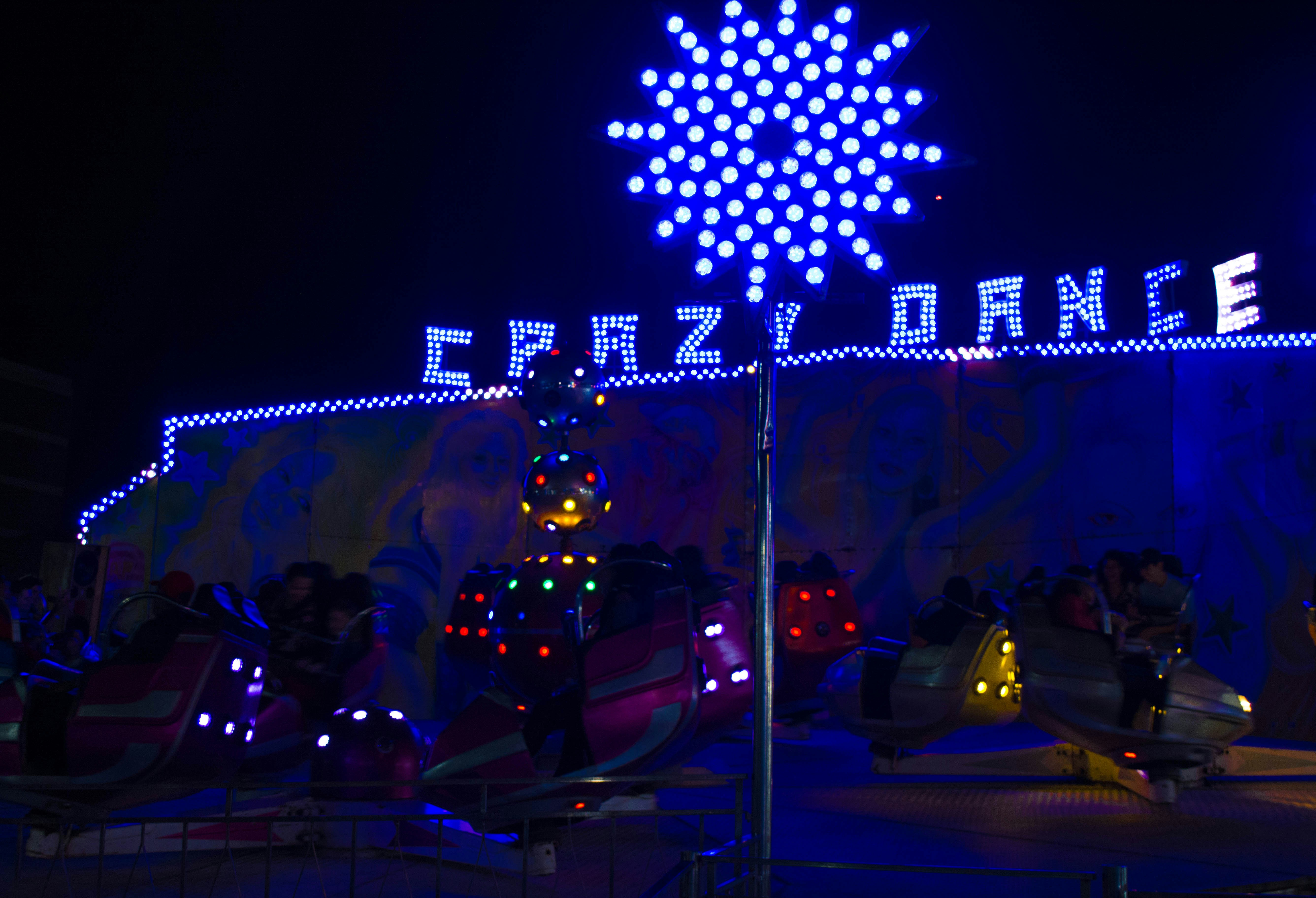 Night Ride: Neon Lights and Daring Dashes at the Amusement Park