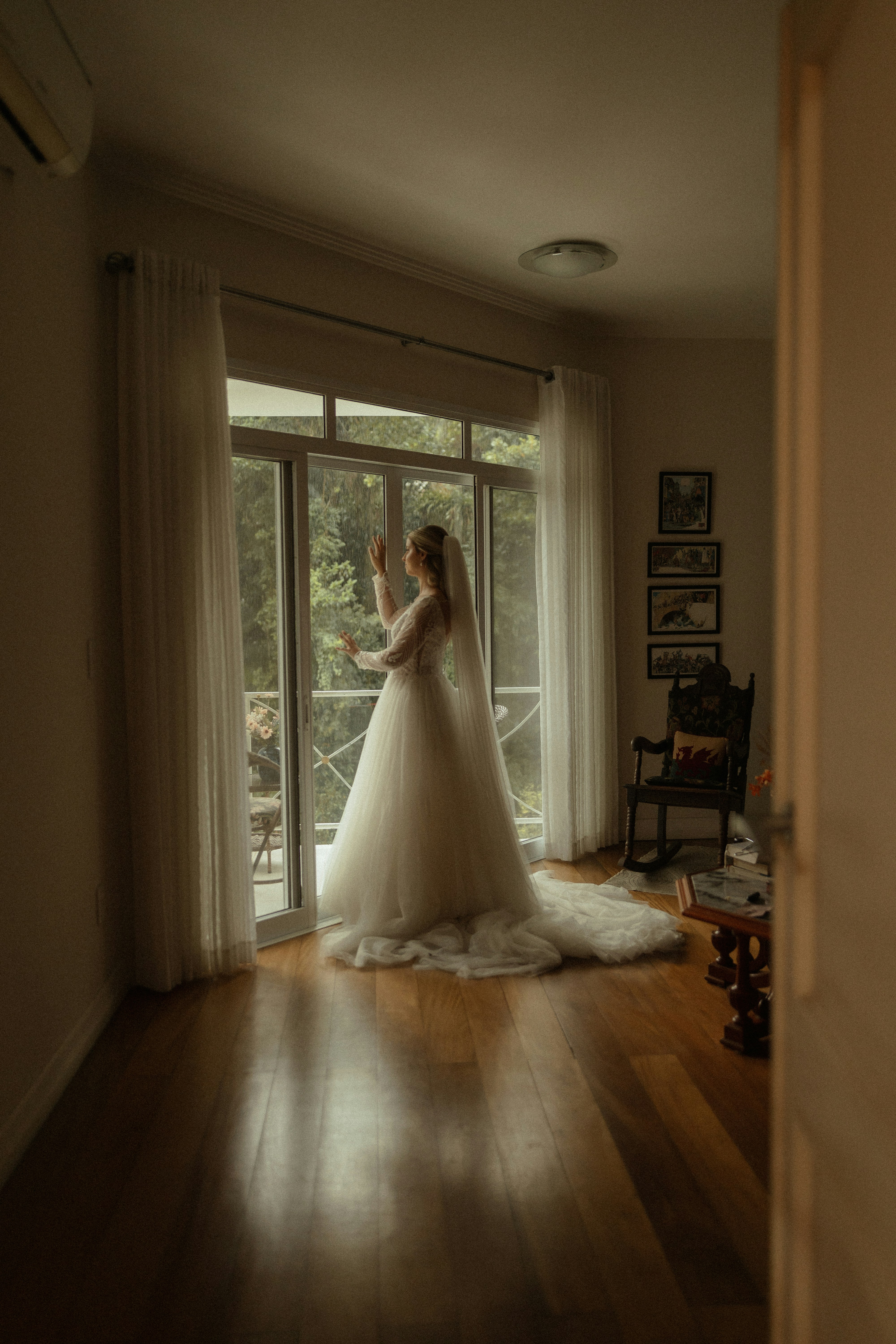 Bride in Soft Morning Light Seated by Balcony Door