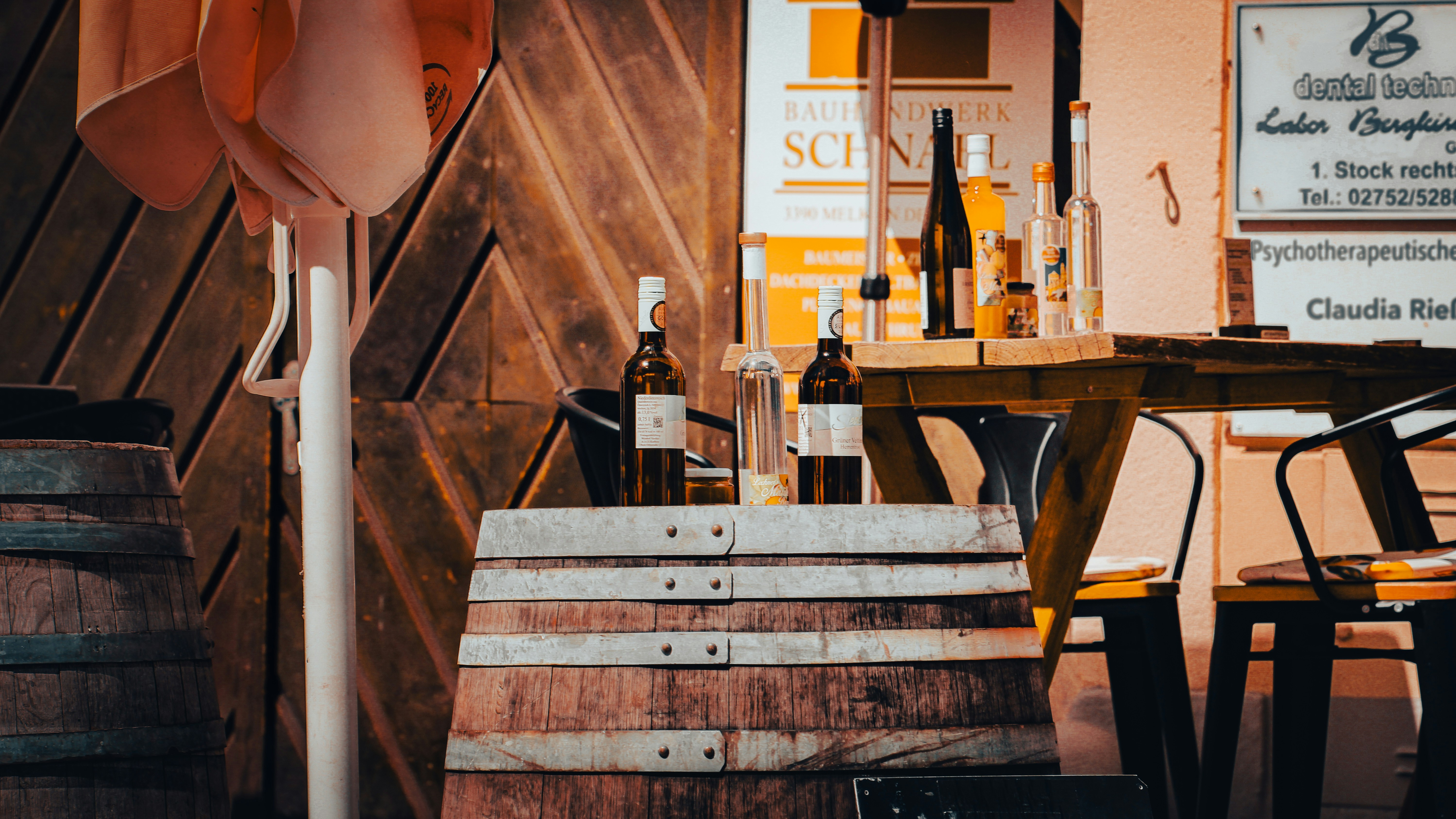 Barrels, Bottles, and Warm Light: A Quiet Still Life of a Rustic Table