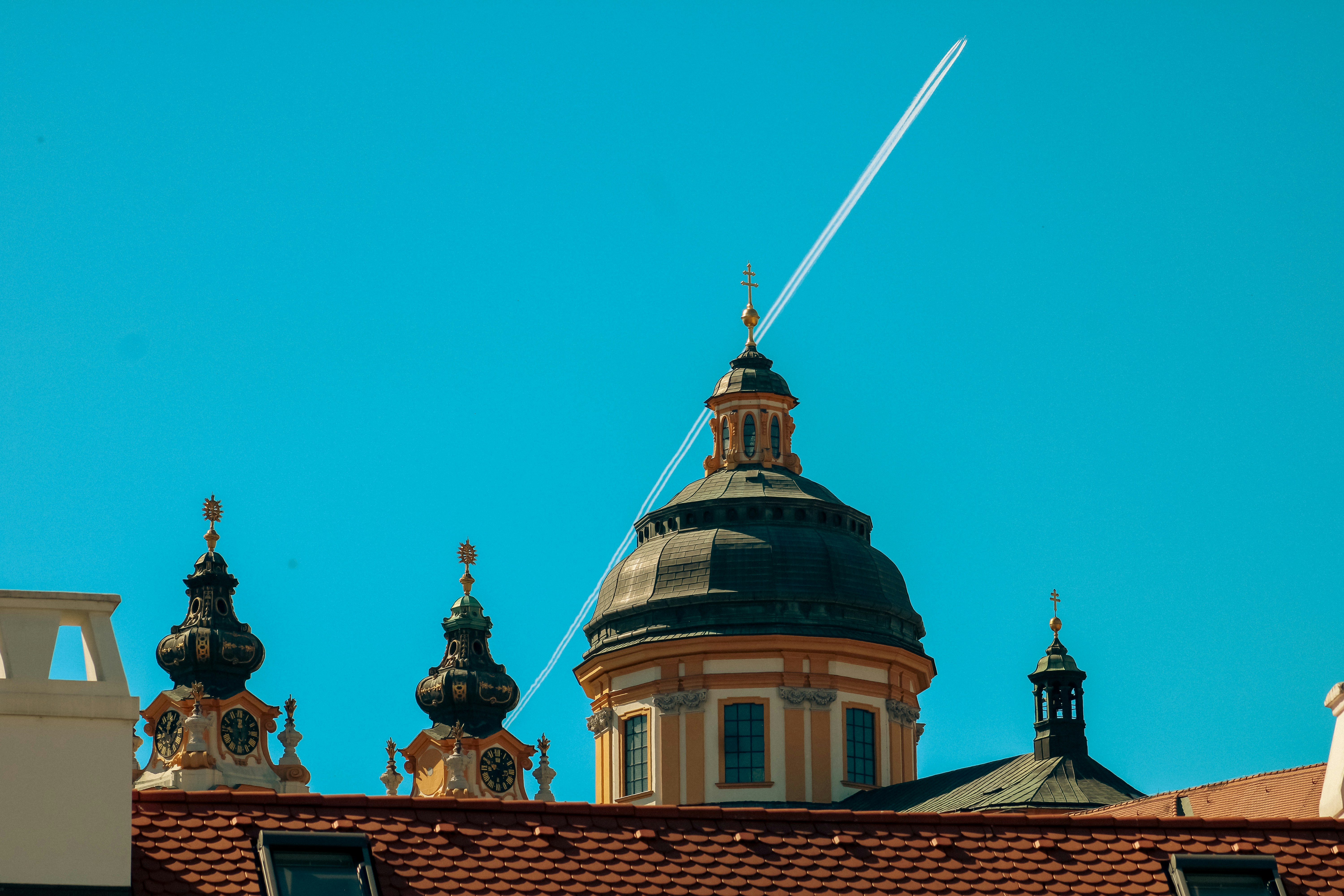 Roofline Majesty: A Turreted Skyline Beneath a Bold Blue Sky